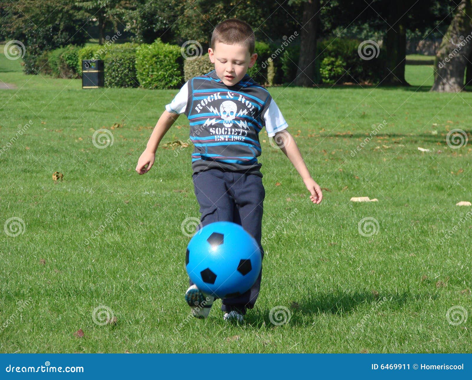 Boy kicking football stock image. Image of happy, kicking - 6469911