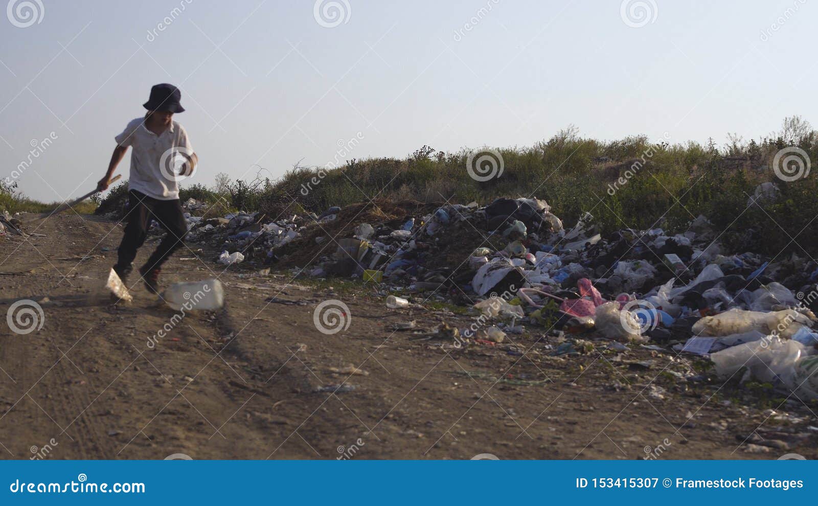 Boy Kicking Plastic Can in Dump Stock Image - Image of poor, boredom ...