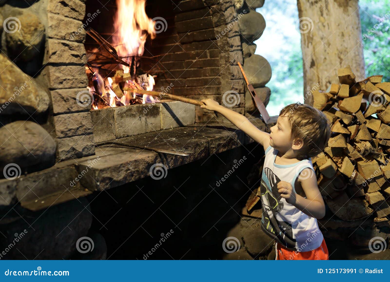 Boy Kindles Fire in Fireplace Stock Image - Image of camping, barbecue ...