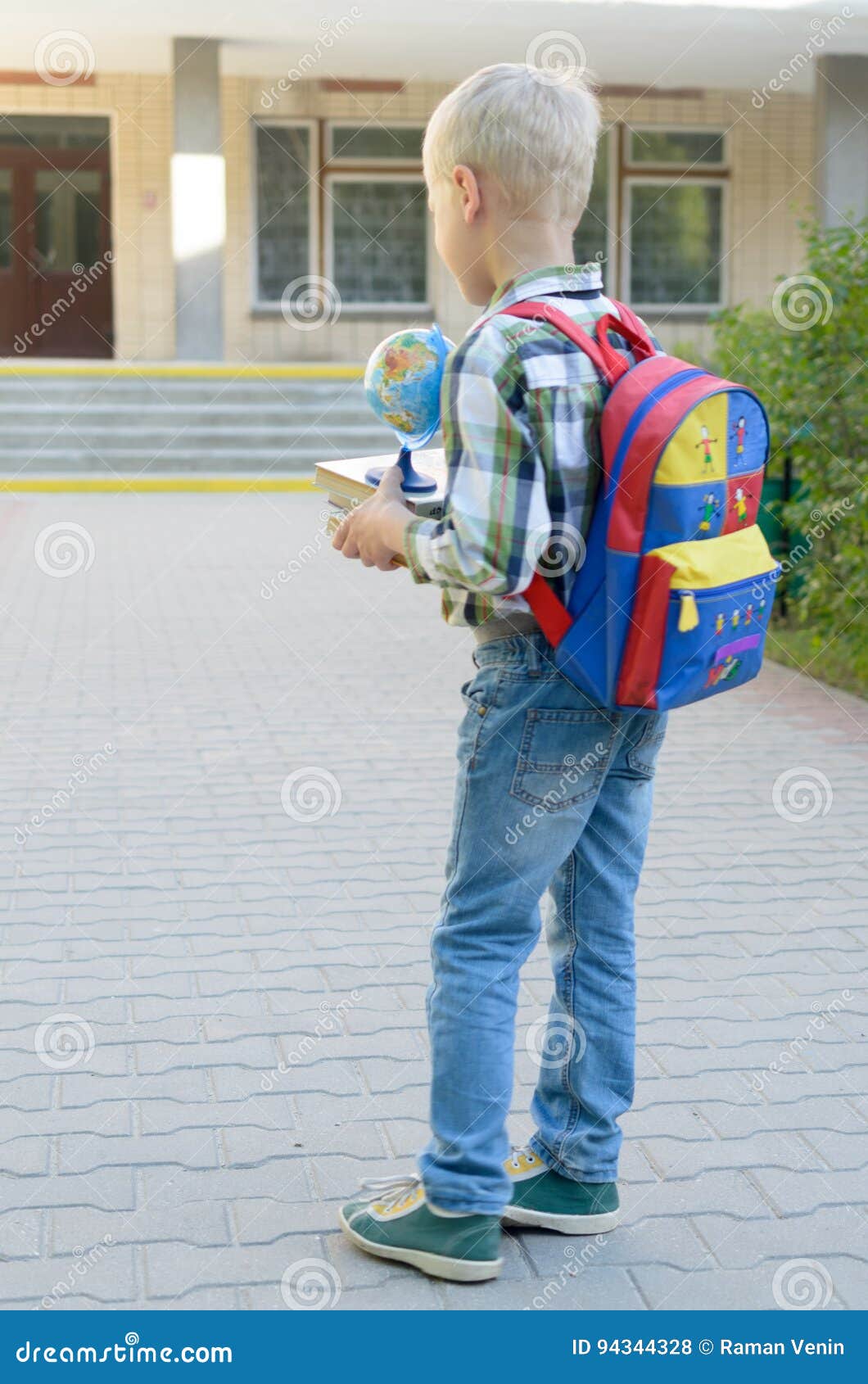 A Boy with a Knapsack, Books and a Globe Goes To School after a Long ...