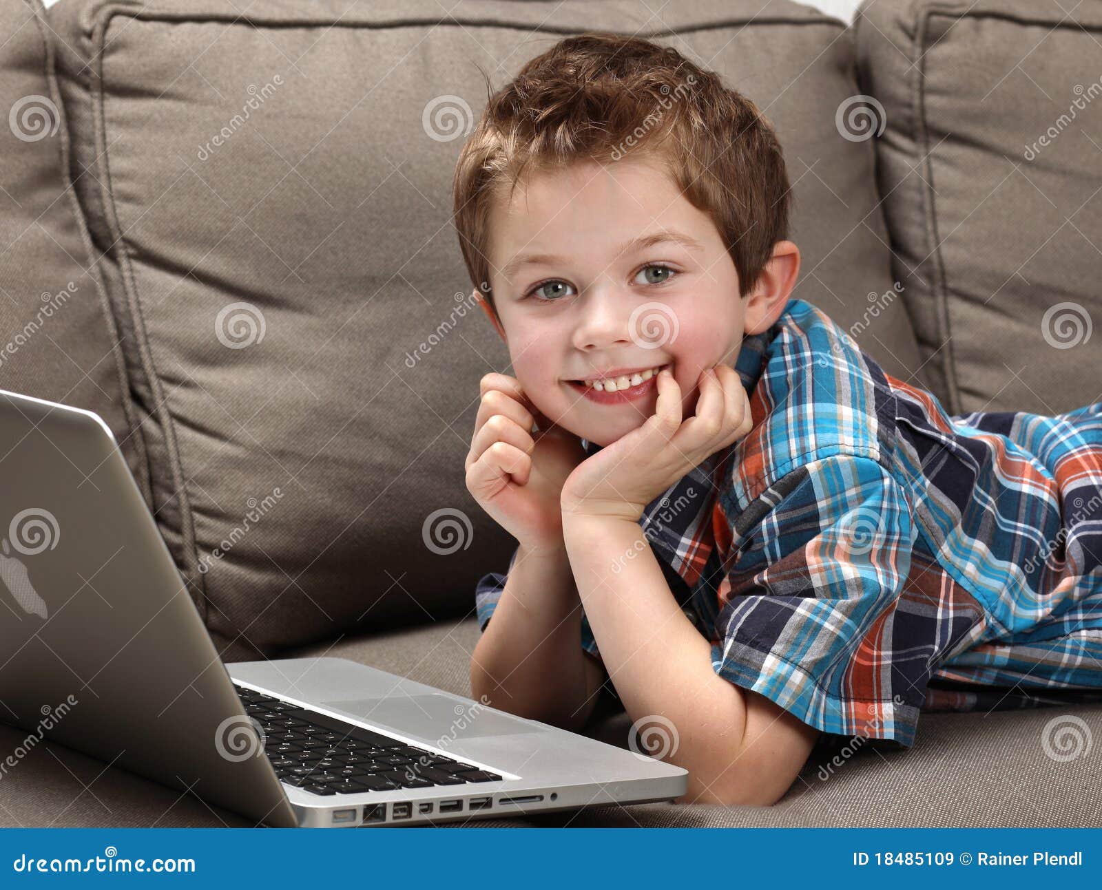 Boy with laptop stock image. Image of grey, sofa, technology - 18485109