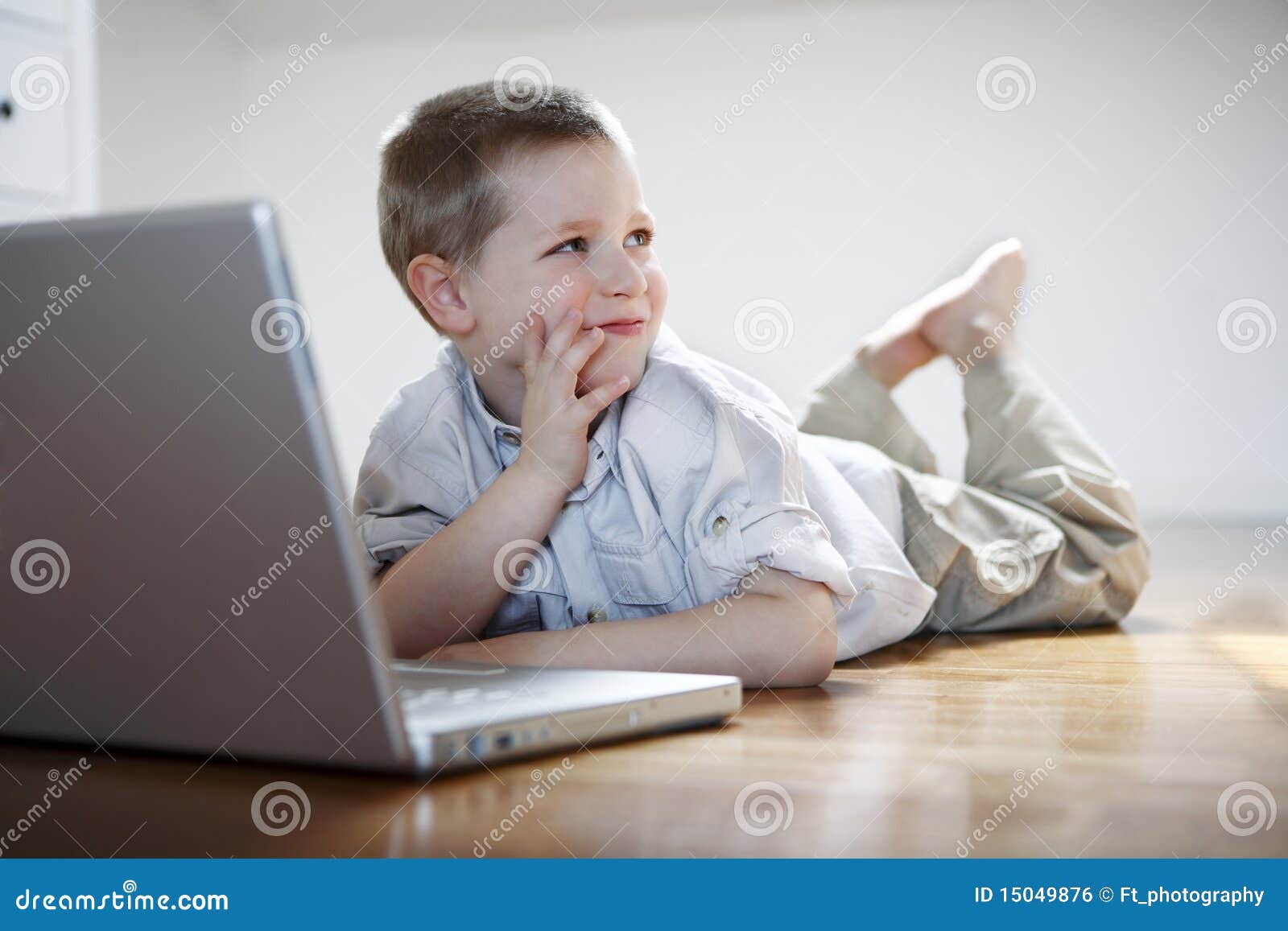 Boy with Laptop Computer Laying Down on the Floor Stock Photo - Image ...