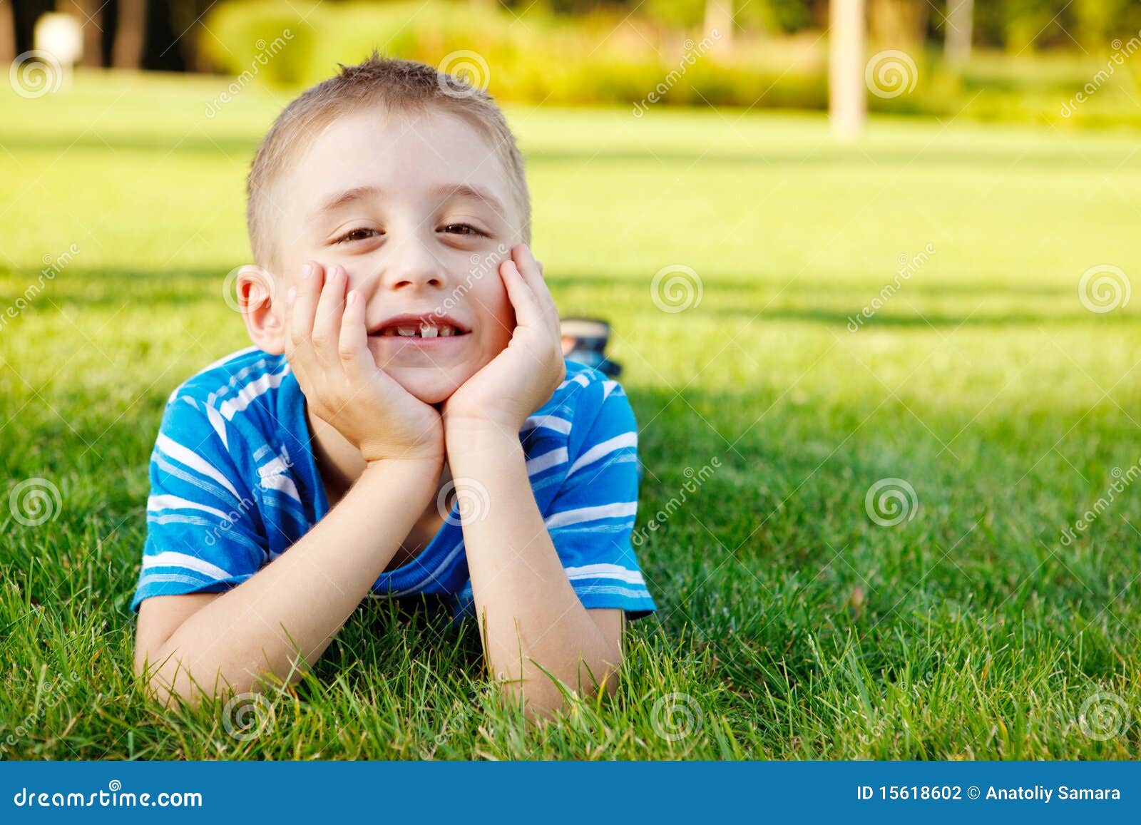 Boy laughing stock photo. Image of looking, grass, cute - 15618602