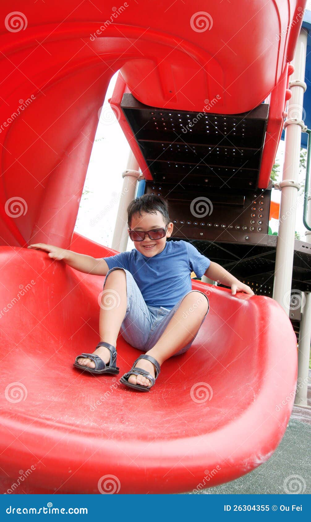 Boy Laughing and Sliding Down on a Spiral Slide Stock Image - Image of ...
