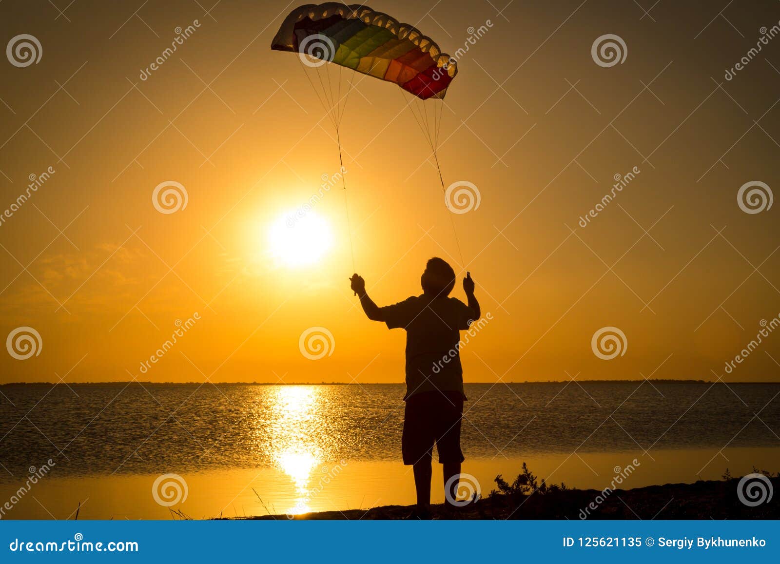 Boy Launching the Rainbow Kite at Sunset Stock Image - Image of nature ...