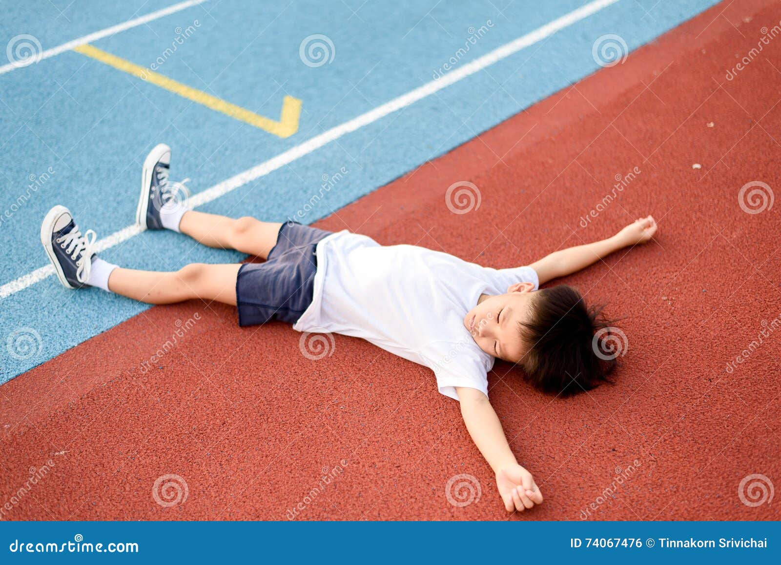 Boy Lay on the Running Track Stock Photo - Image of happy, field: 74067476
