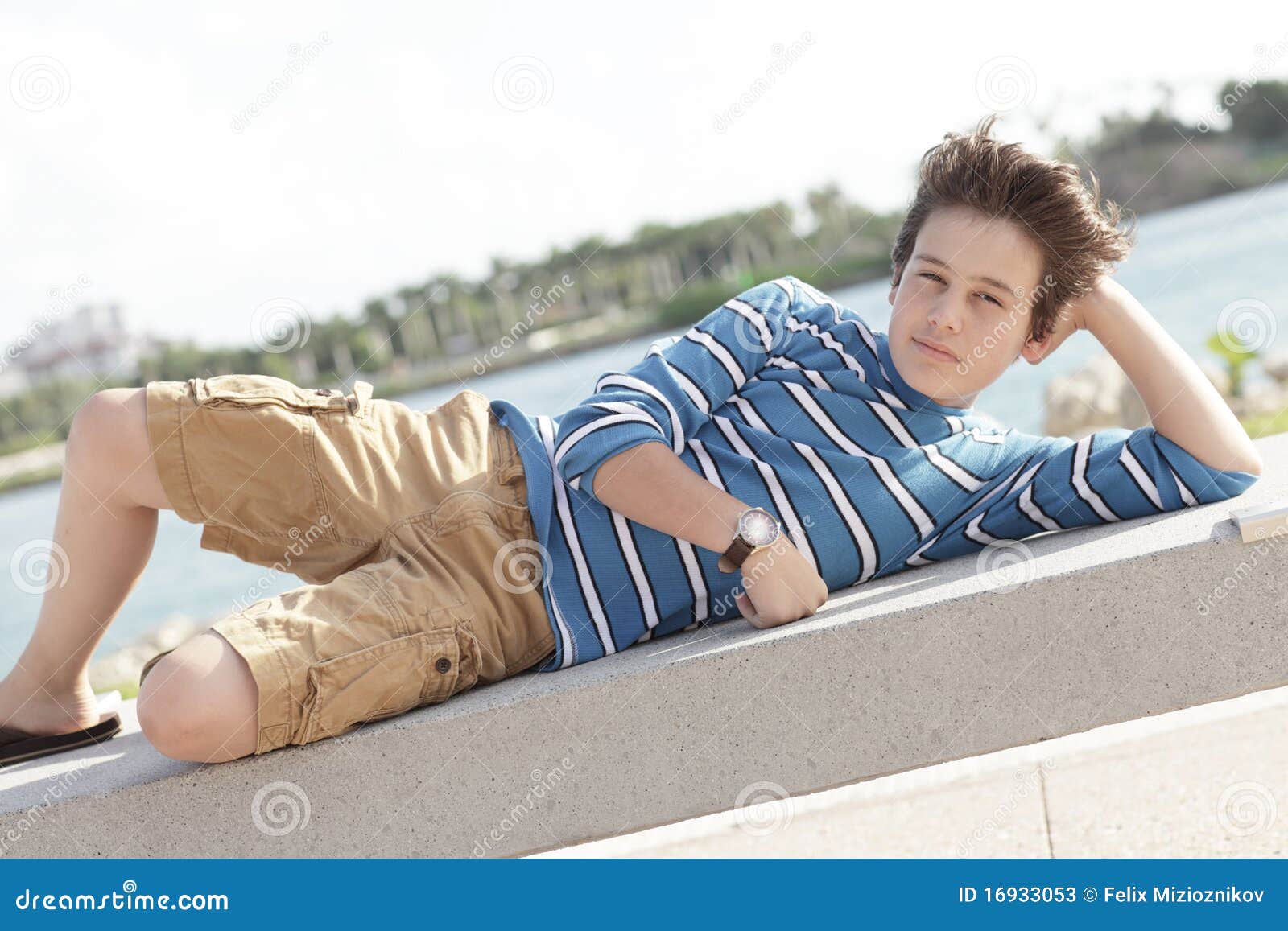 Boy laying on a bench stock image. Image of person, adolescent - 16933053