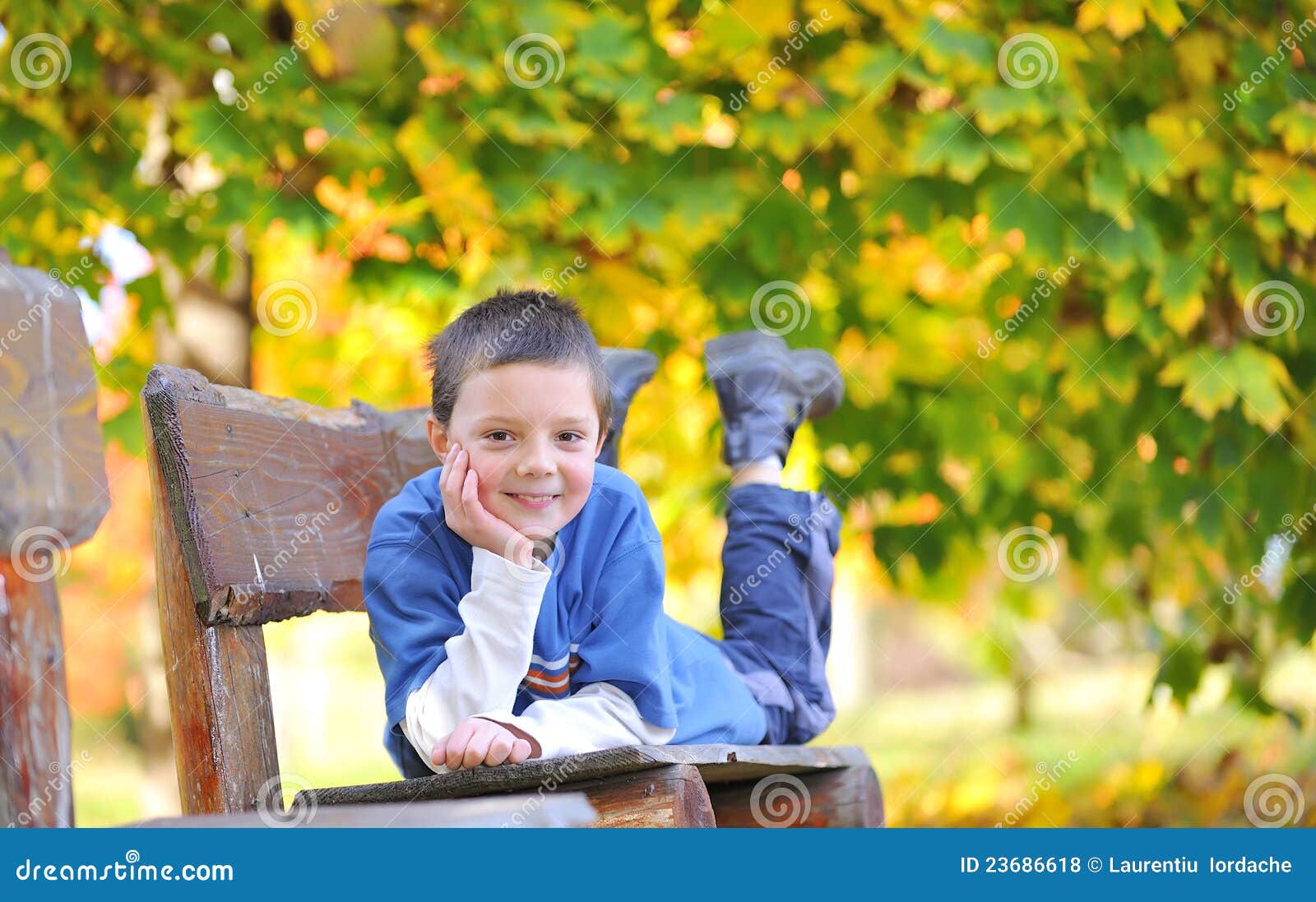Boy laying down on a bench stock photo. Image of lifestyle - 23686618
