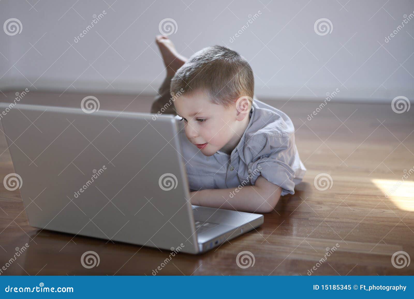 Boy Laying Down on the Floor with Laptop Computer Stock Image - Image ...