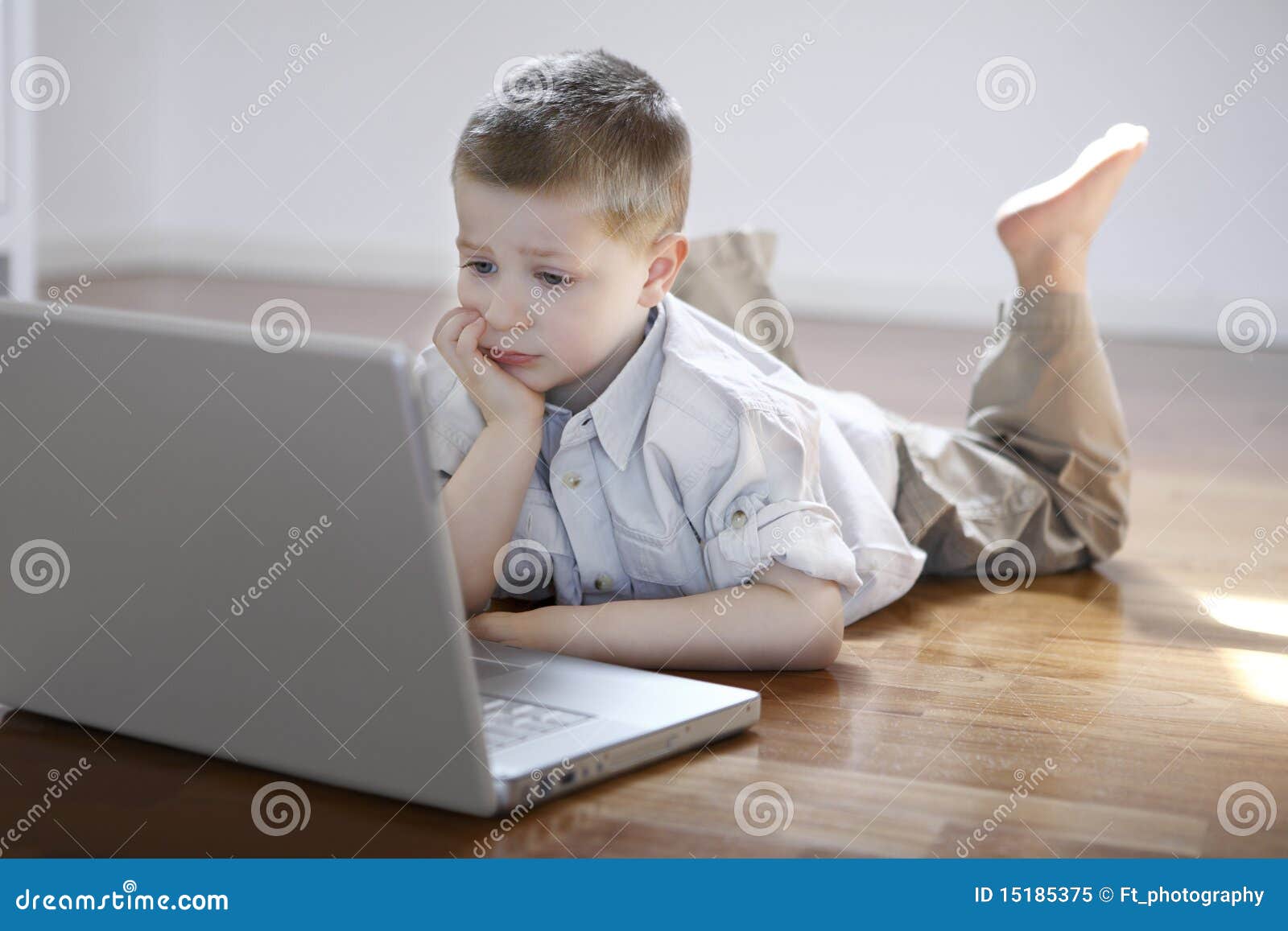 Boy Laying Down on the Floor with Laptop Computer Stock Image - Image ...