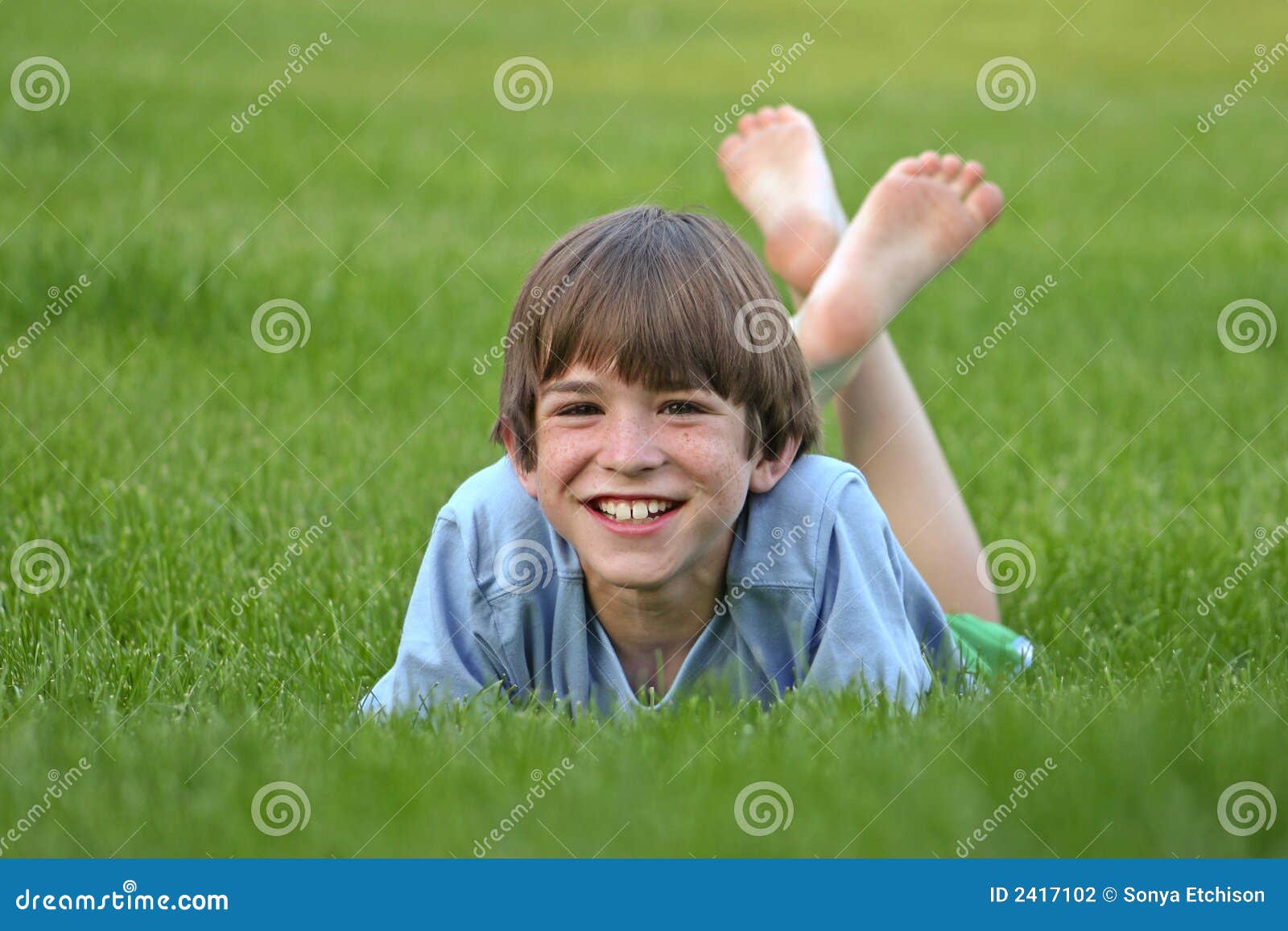 Boy Laying In Grass Stock Photography - Image: 2417102