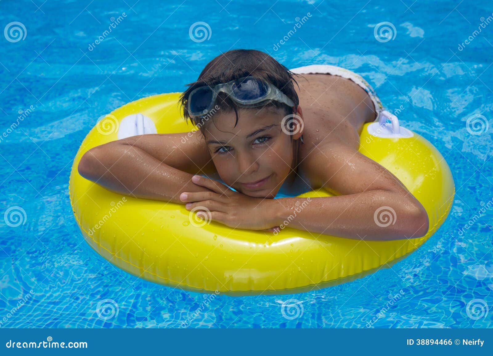 Boy Laying on Rubber Ring in Pool Stock Photo - Image of googles ...