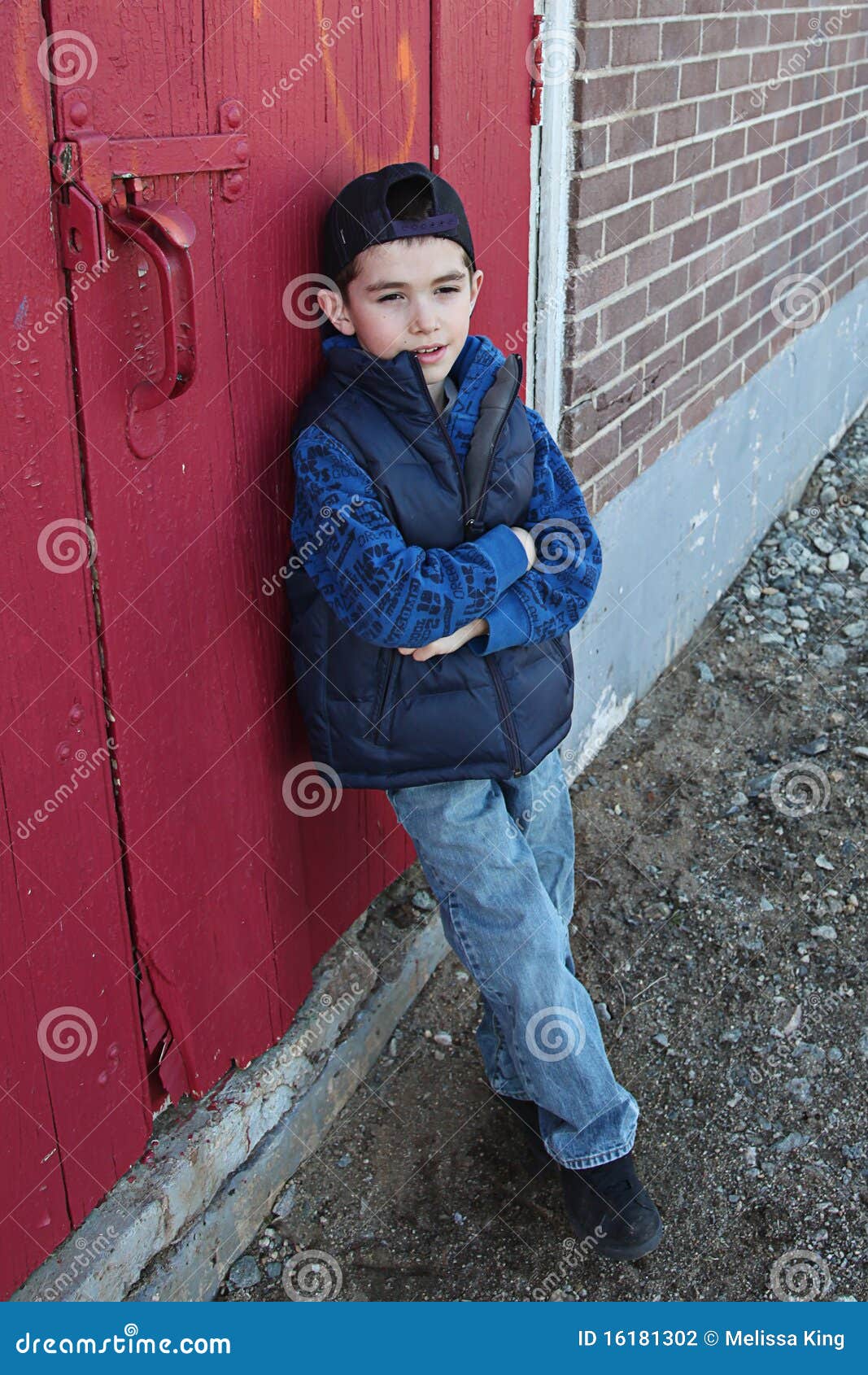 Boy leaning against door stock photo. Image of jeans - 16181302