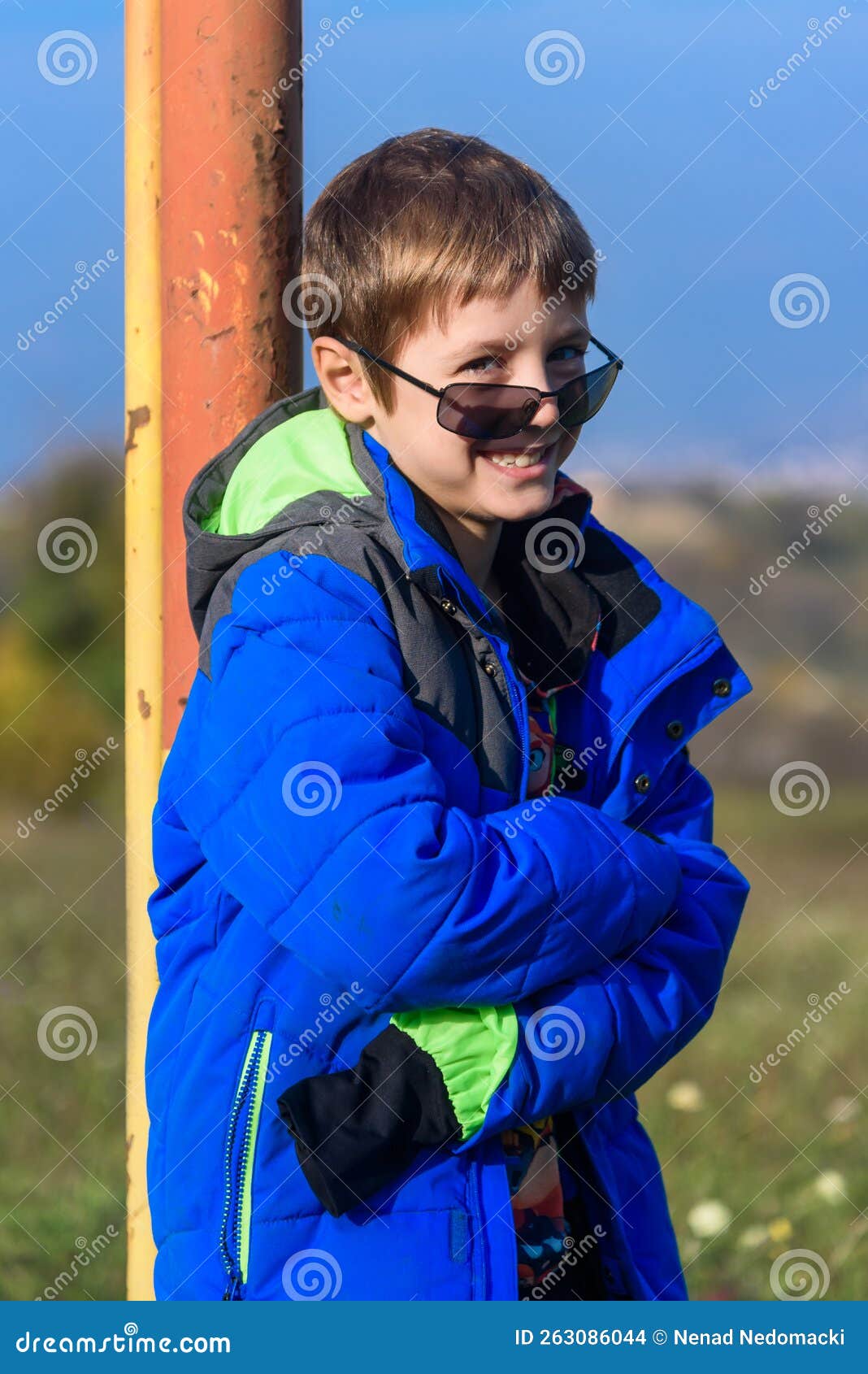 A Boy Leaning on a Metal Bar. a Boy Leaning Against a Goal Post Stock ...