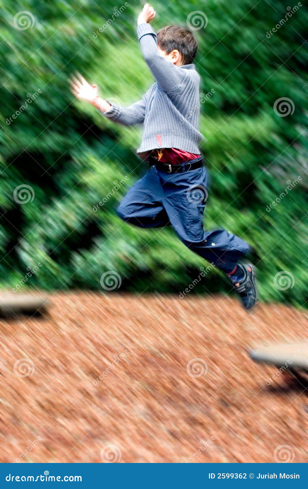 Boy Leaps High in Playground Stock Photo - Image of movement, outdoors ...
