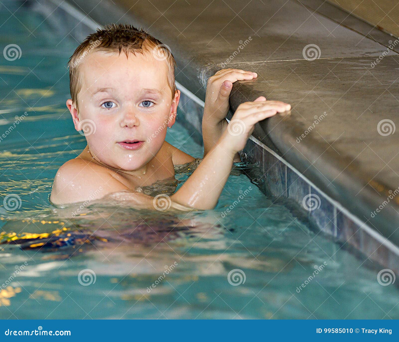 Boy learning how to swim stock photo. Image of energetic - 99585010