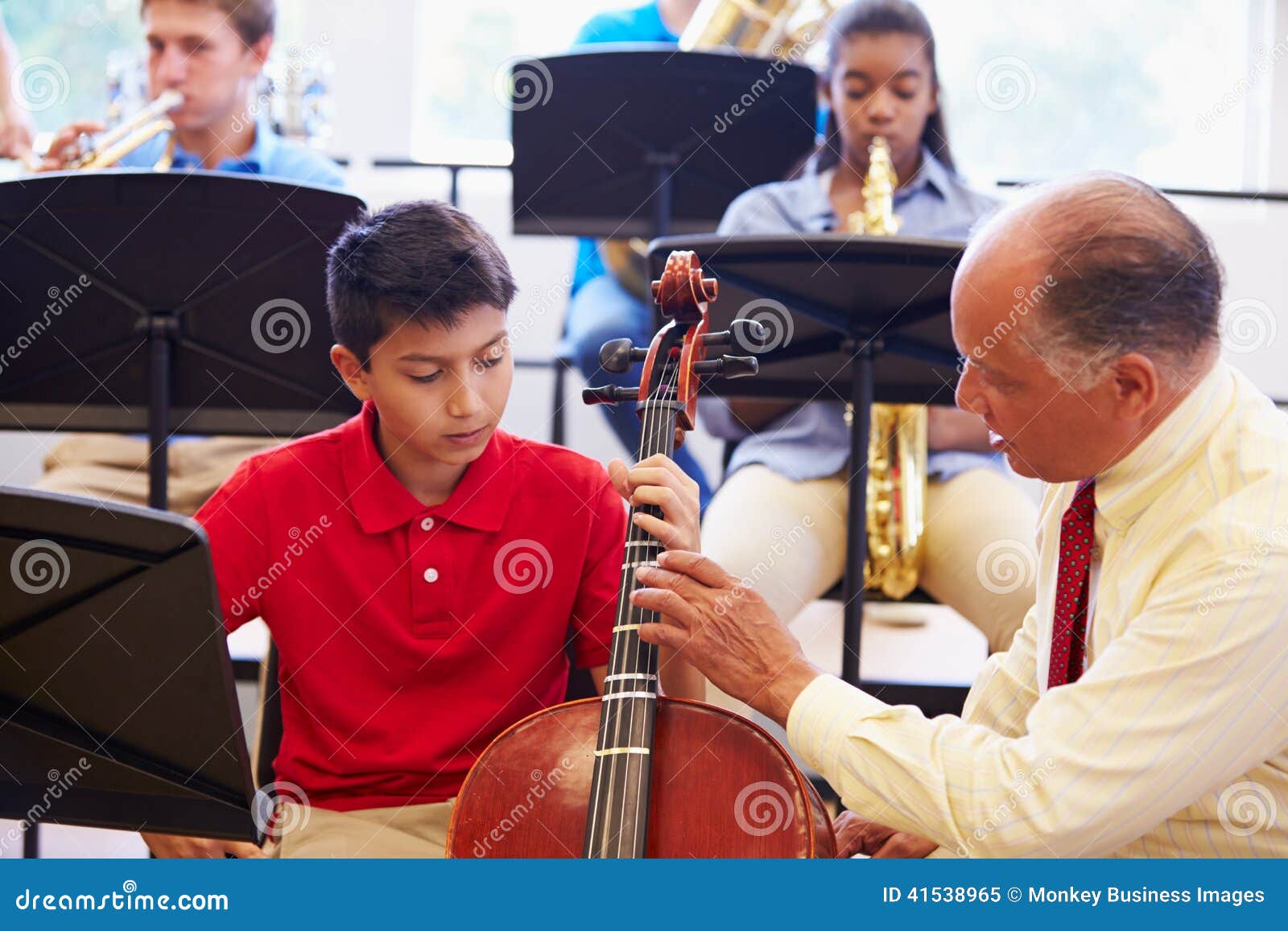 Boy Learning To Play Cello in High School Orchestra Stock Image - Image ...