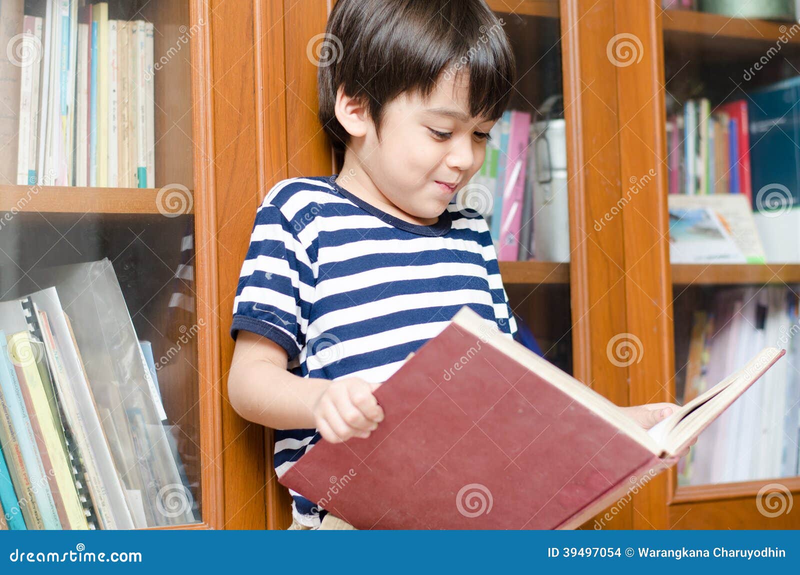 Boy in Library Holding Book Studying Stock Photo - Image of shelf ...