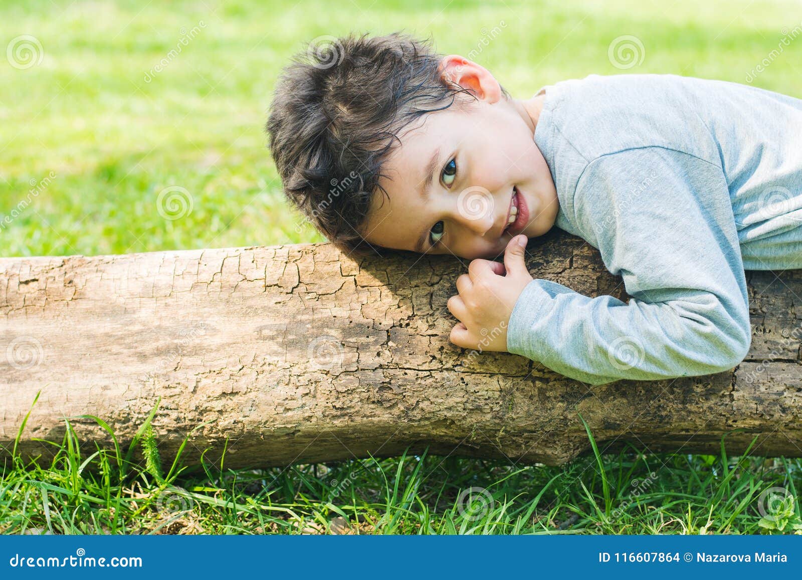 Boy lies on a log stock photo. Image of forest, small - 116607864