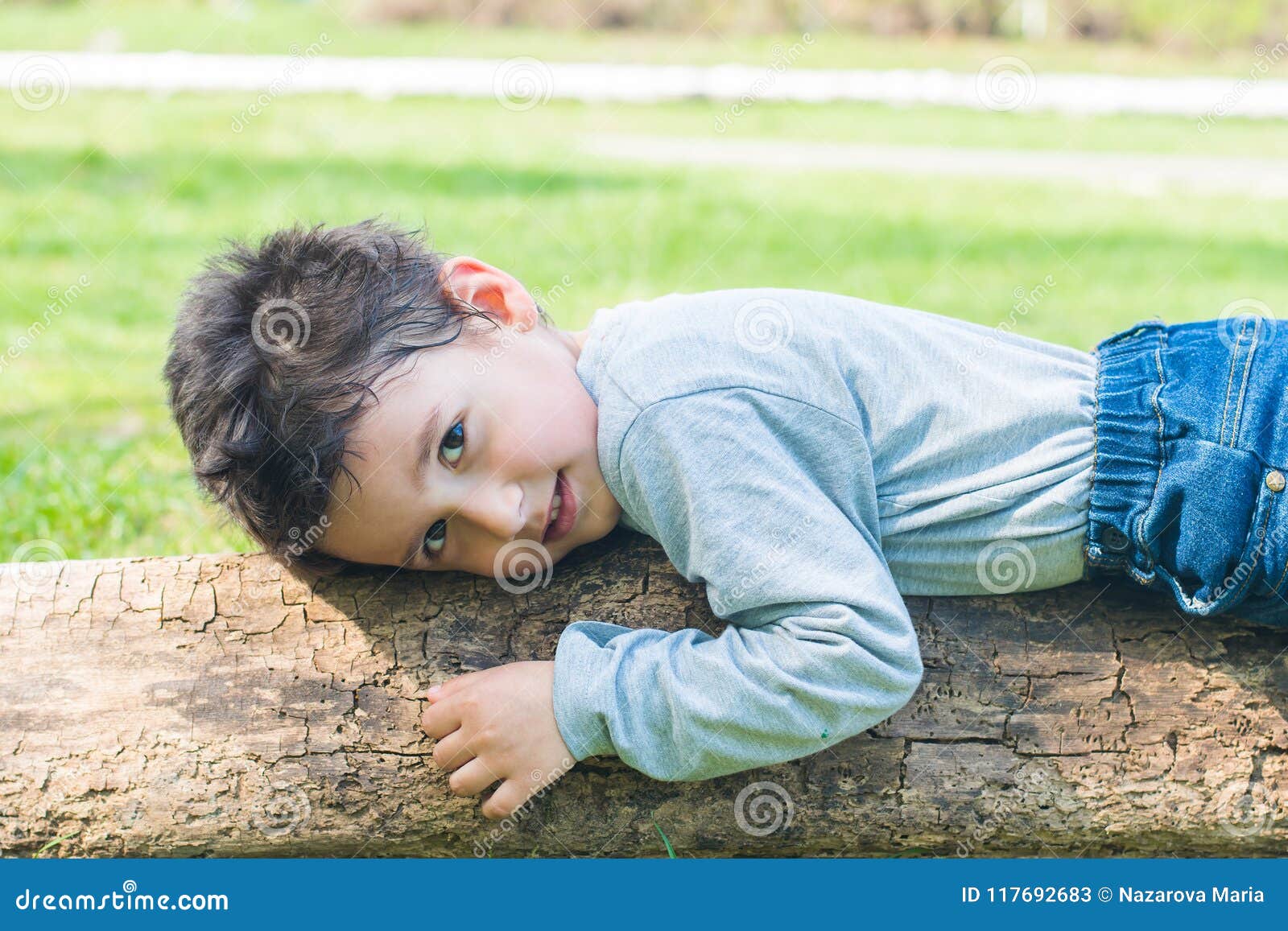 Boy lies on a log stock image. Image of hair, child - 117692683