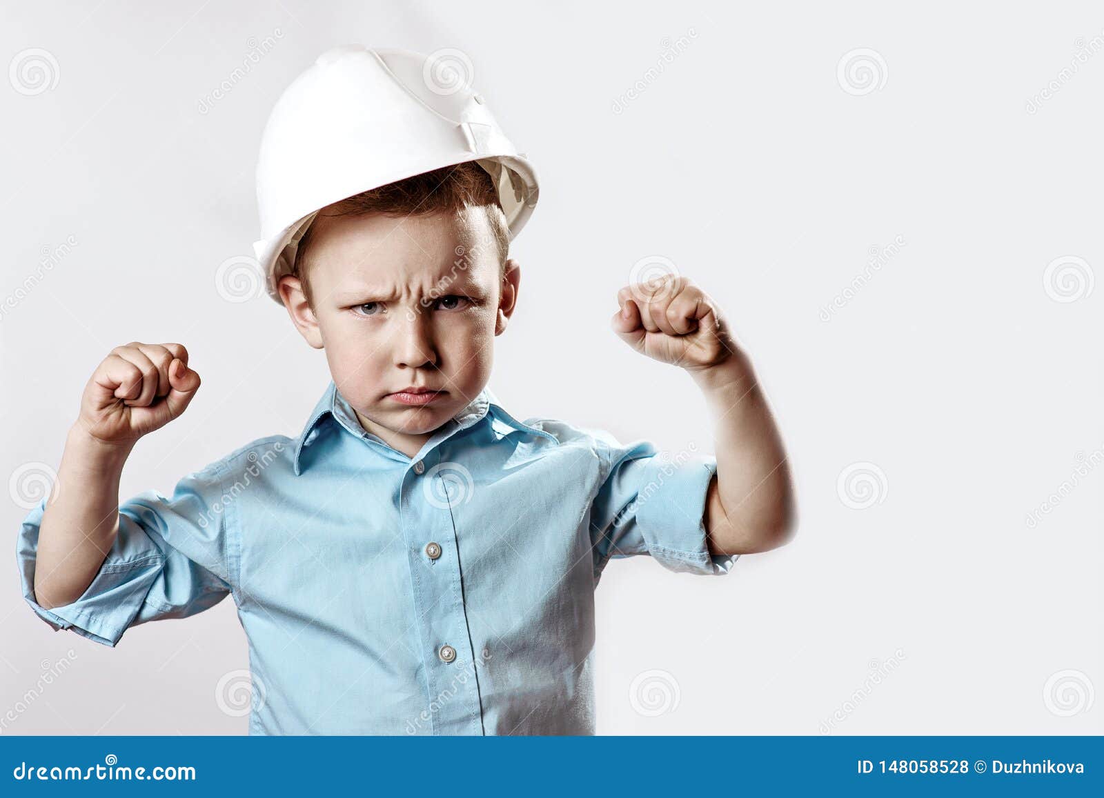 Boy in a Light Shirt and Helmet Builder Shows How he is Strong and ...