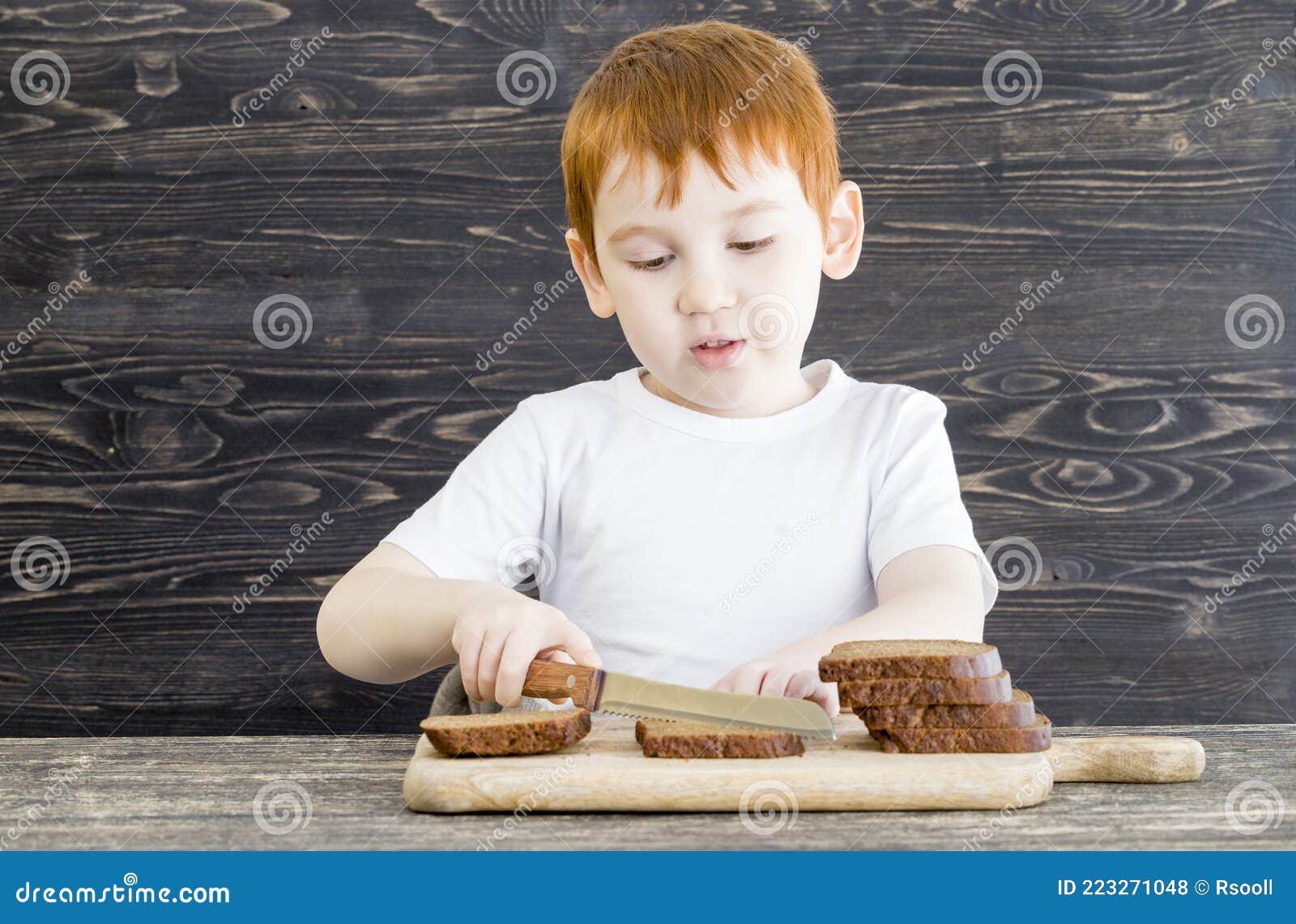 Boy with a loaf of bread stock photo. Image of fresh - 223271048