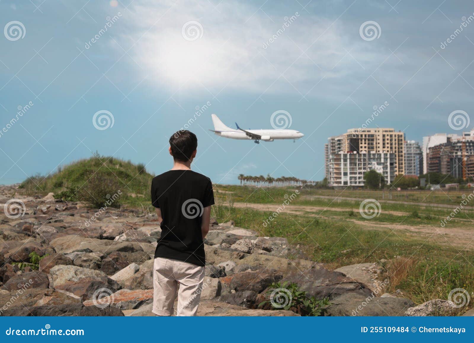 Boy Looking at Airplane Flying, Back View Stock Photo - Image of blue ...