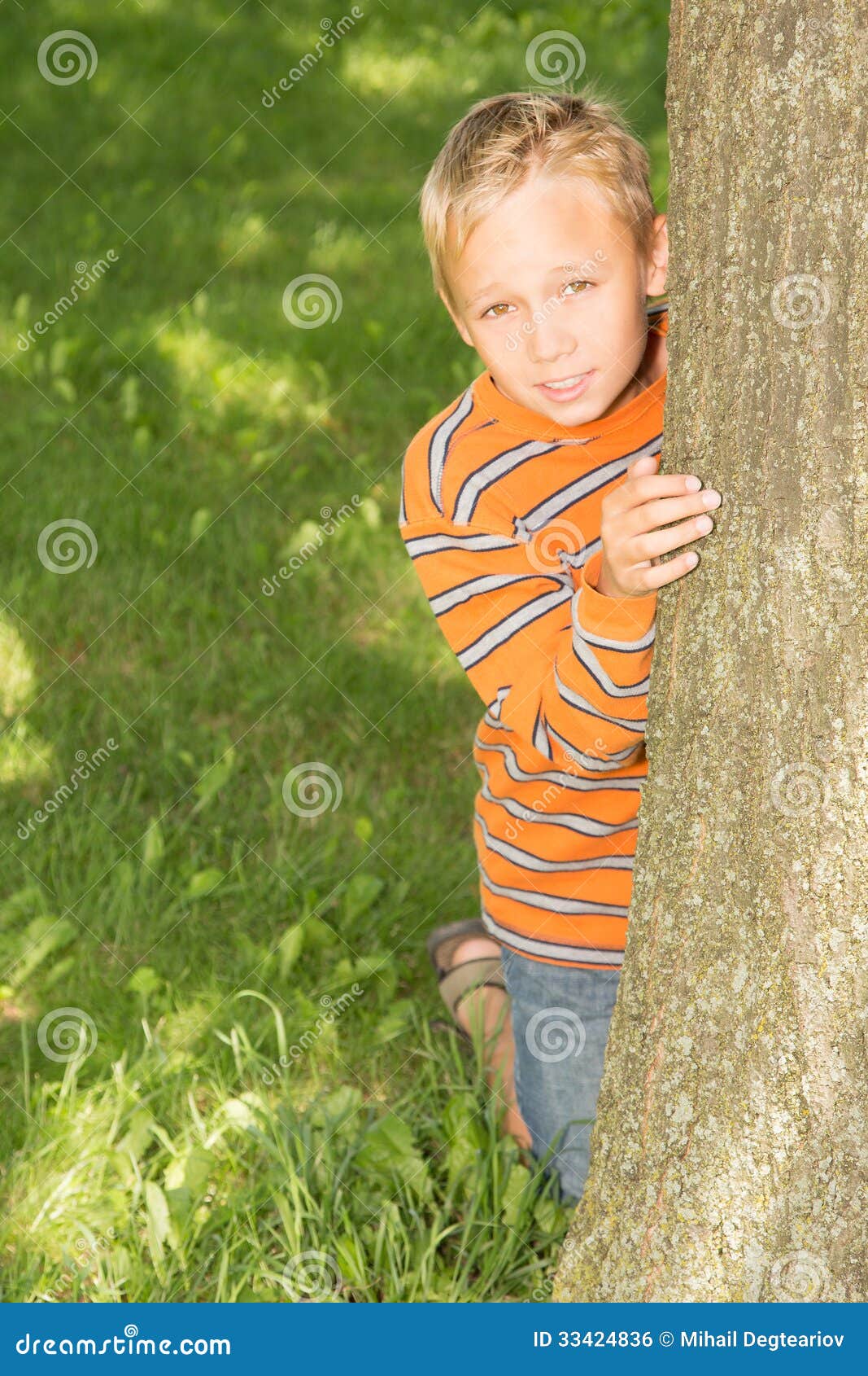 Boy Looking from Behind a Tree Stock Photo - Image of sandals, look ...