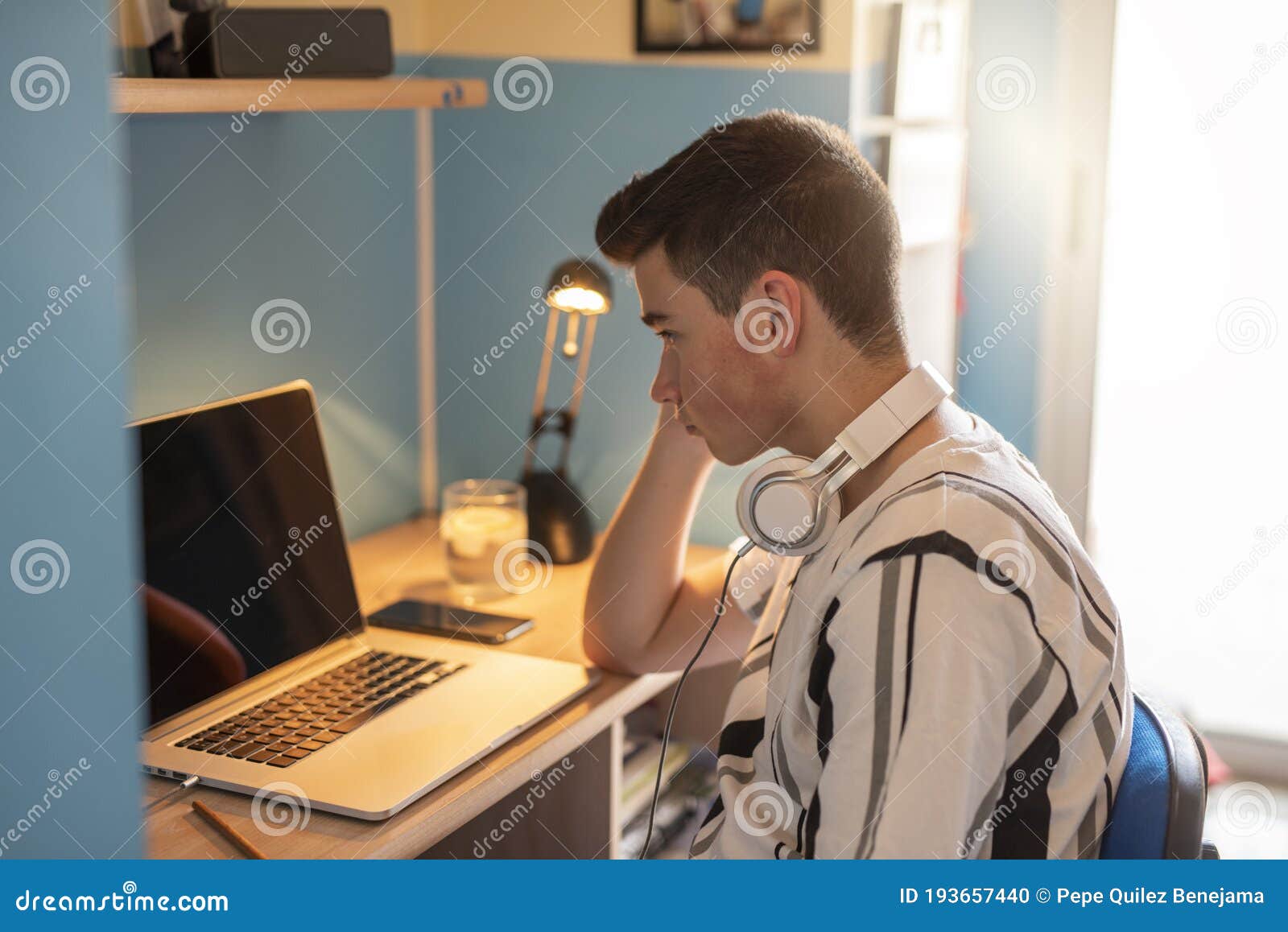 BOY LOOKING BORED at HIS COMPUTER SCREEN Stock Photo - Image of ...