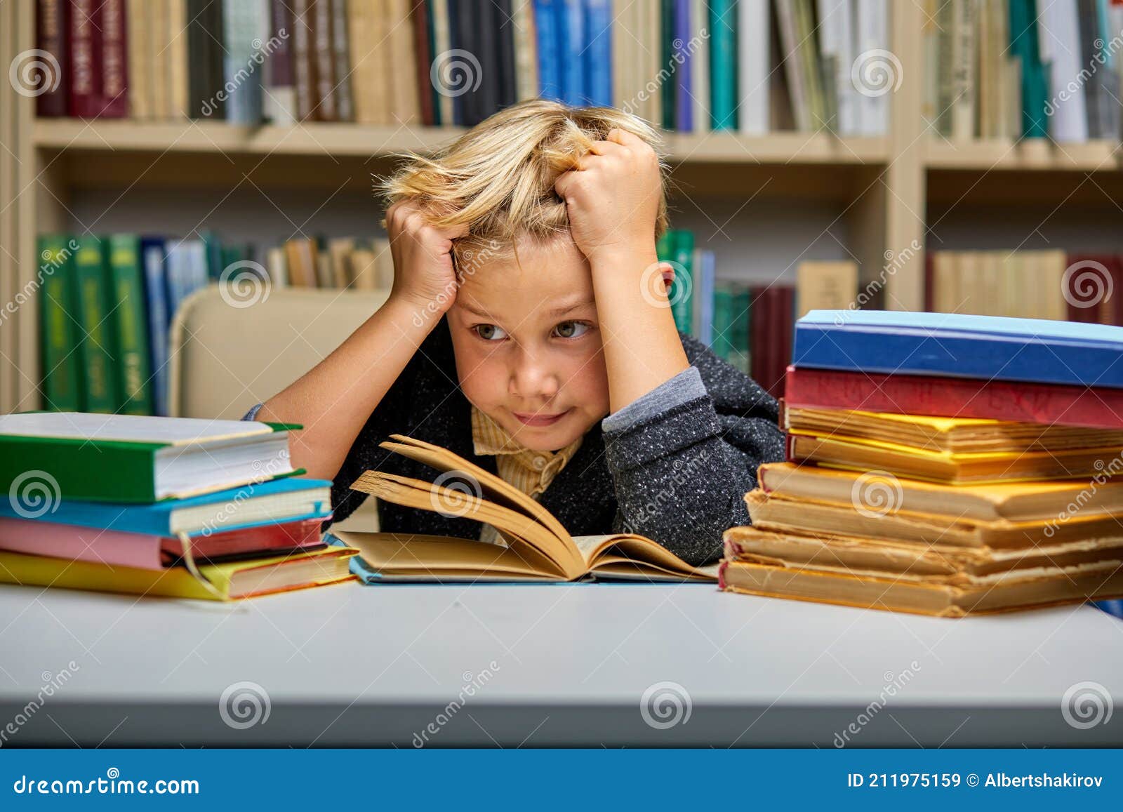 Boy Looking Bored while Studying at the Library Stock Image - Image of ...