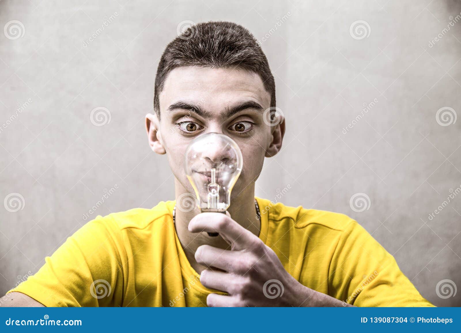 Boy Looking Curiously at a Lightbulb Stock Photo - Image of portrait ...
