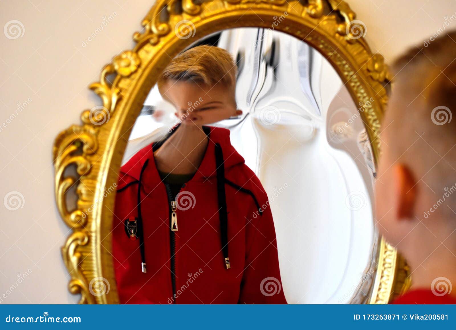 The Child Reflected in a Distorting Mirror. a Fun Reflection of the Boy ...