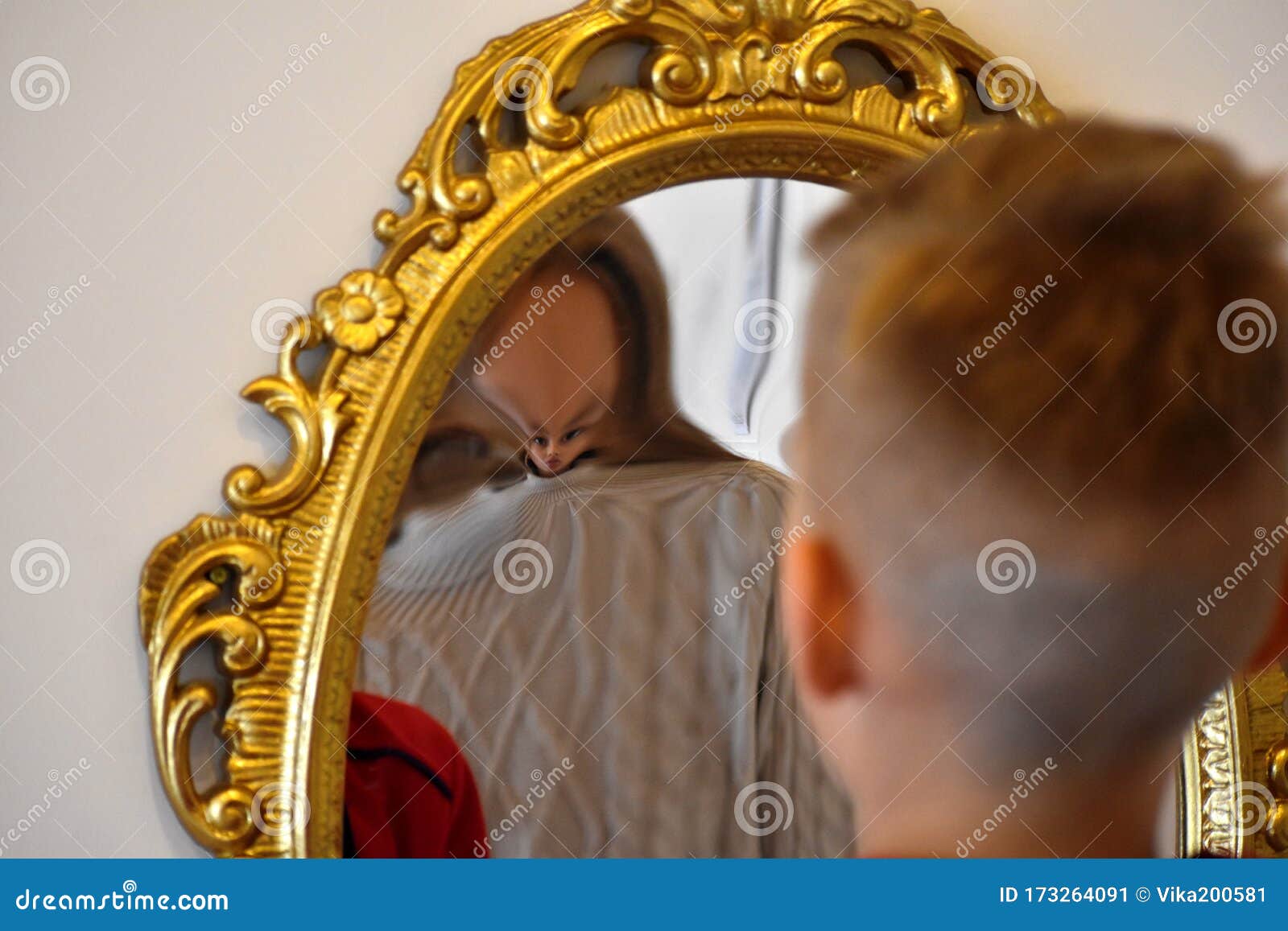 The Child Reflected in a Distorting Mirror. a Fun Reflection of the Boy ...