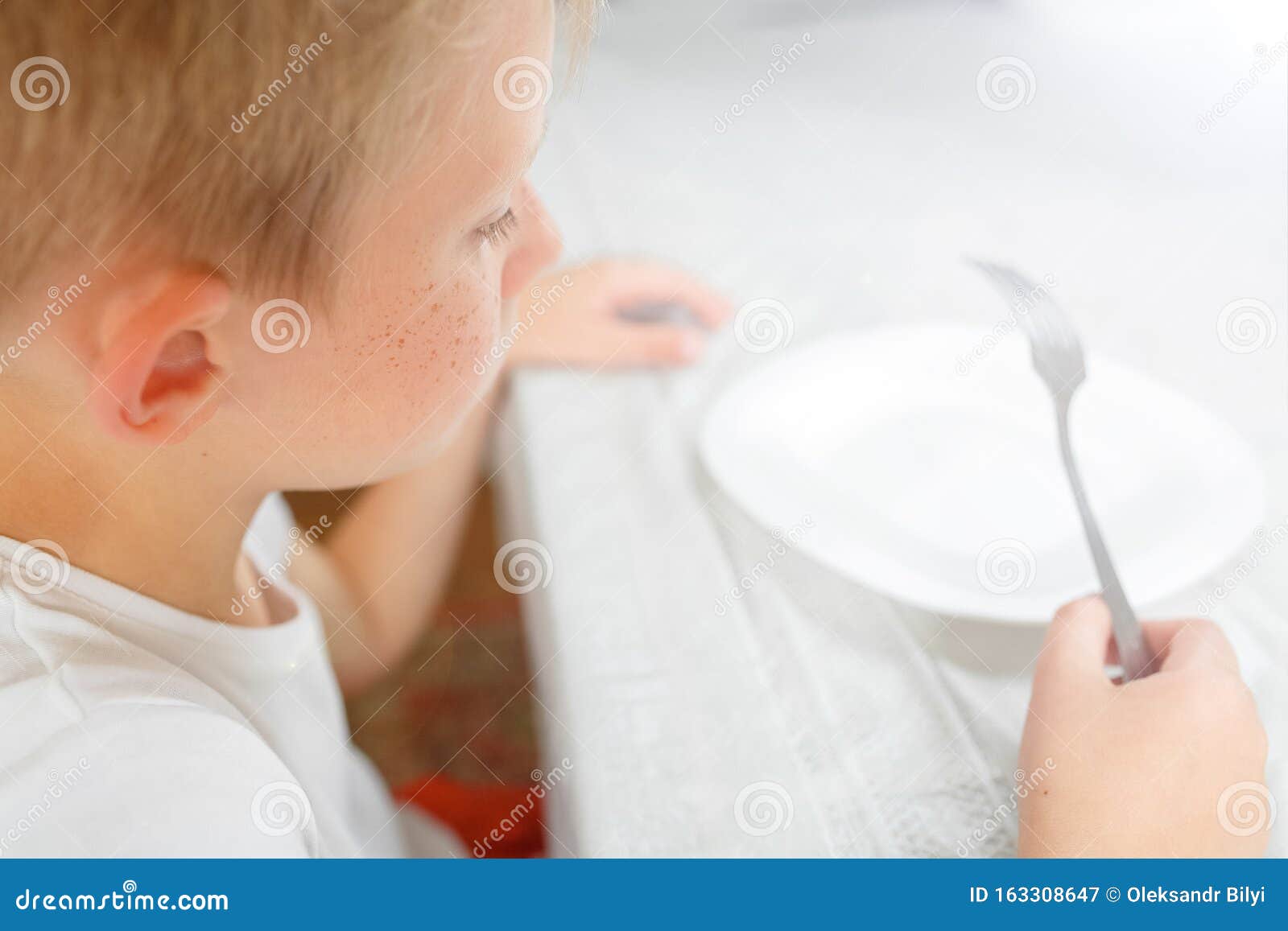 Boy Is Looking At An Empty Plate Stock Image - Image of bowl, fork ...