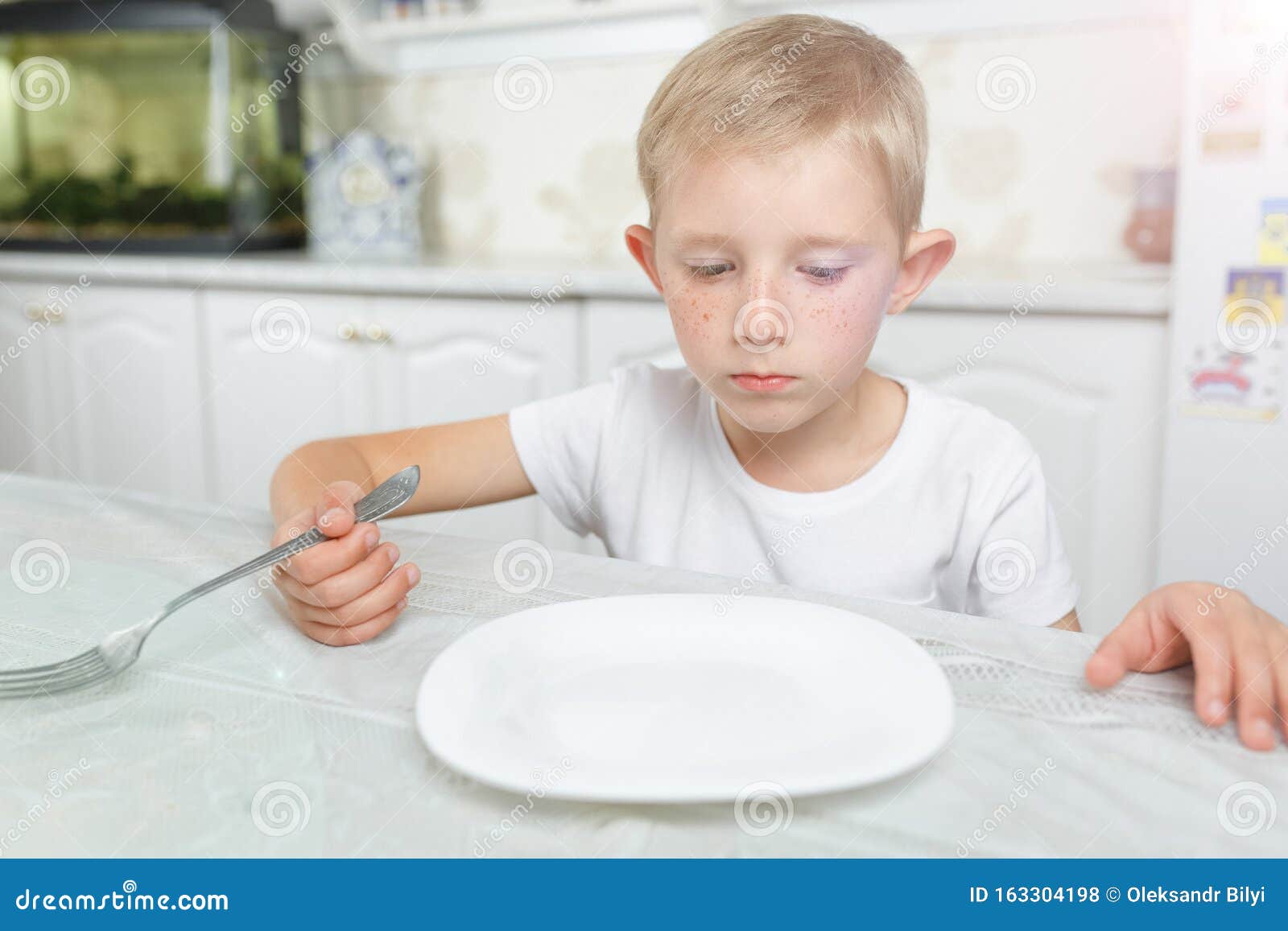 Boy is Looking at an Empty Plate Stock Photo - Image of lunch, hungry ...