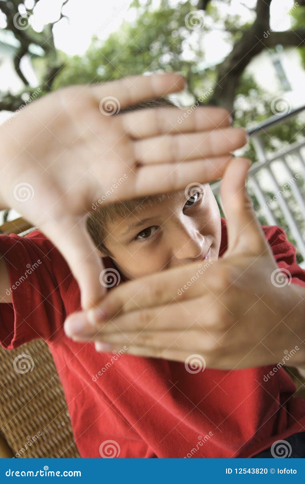 Boy Looking through Hands stock photo. Image of person - 12543820