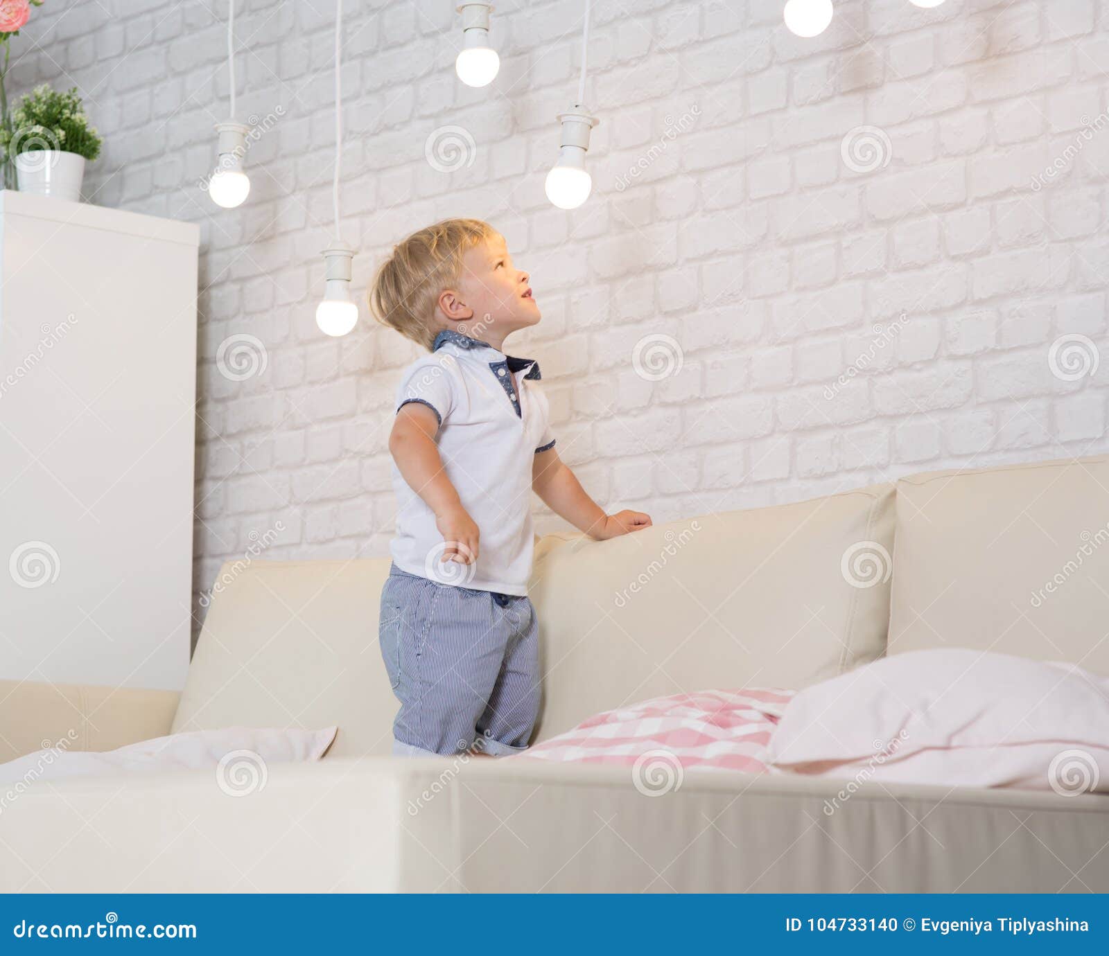 A Boy Looking at a Light Bulb Stock Photo - Image of room, childhood ...