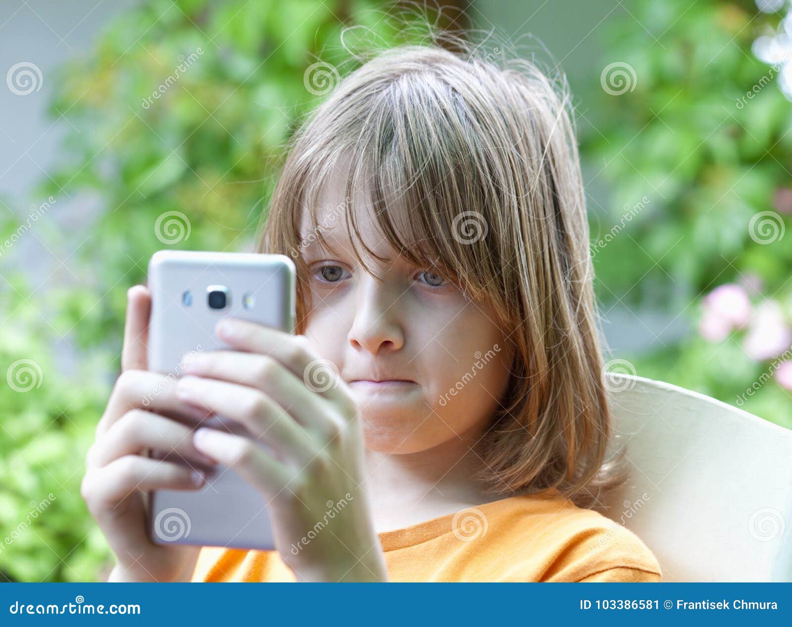 Boy Looking at Mobile Phone Stock Image - Image of portrait, outside ...