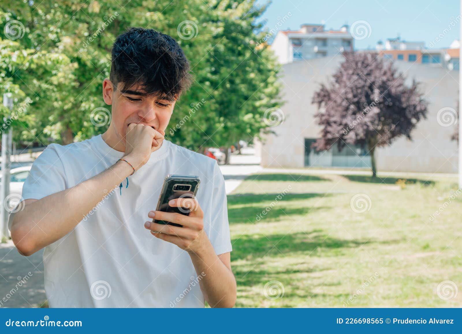 Boy Looking at the Mobile Phone Stock Image - Image of mobile, casual ...