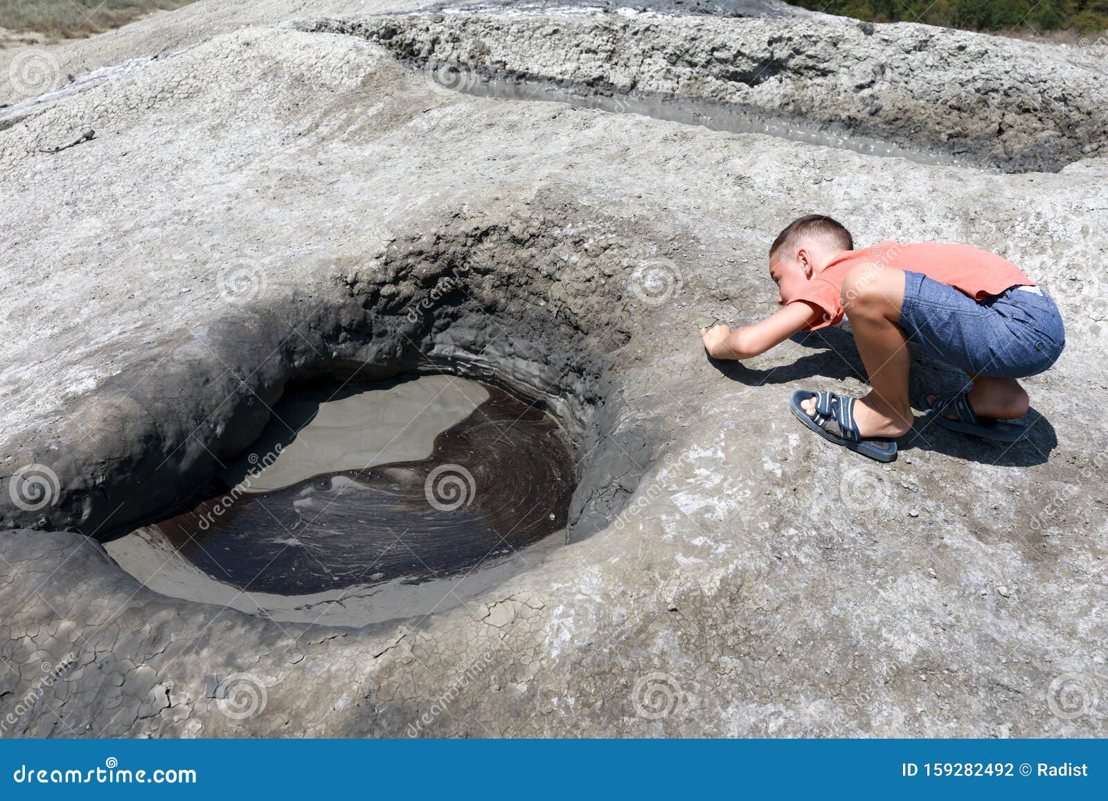 Boy looking at mud pond stock photo. Image of crack - 159282492