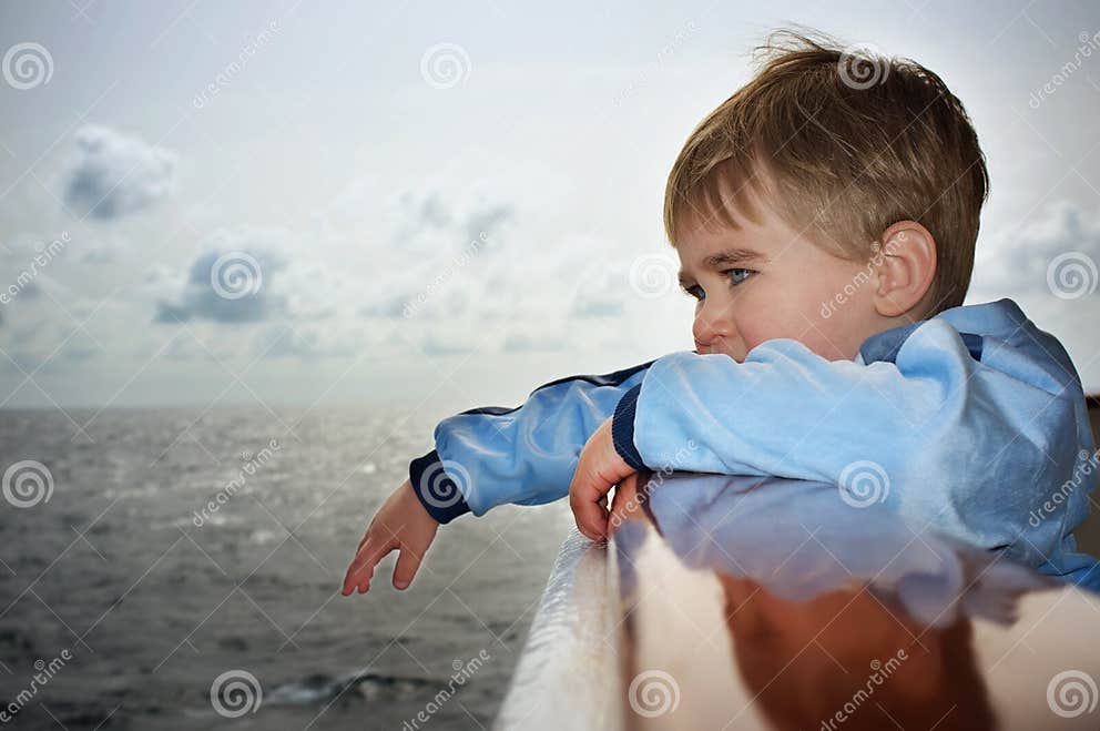 Boy looking at the sea stock photo. Image of closeup - 27363682