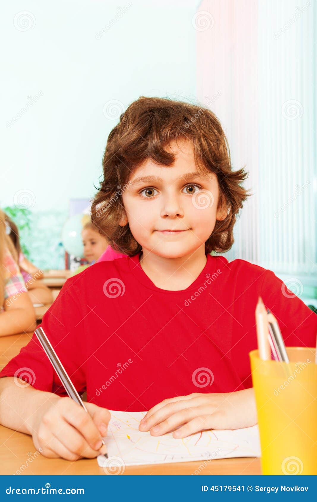 Boy Looking Straight and Writing in Exercise Book Stock Image - Image ...