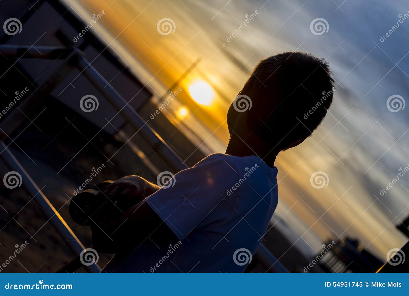 Boy looking at sunset stock image. Image of leaning, pier - 54951745