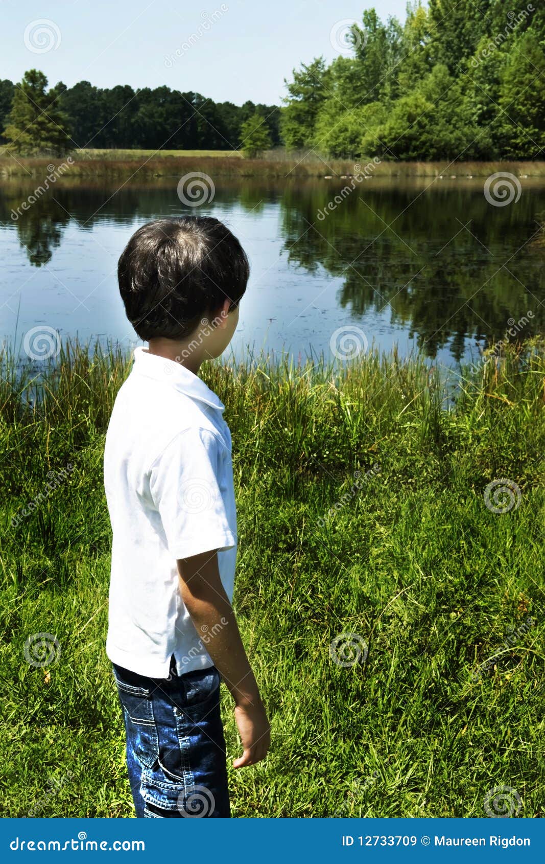 Boy looking at the water stock image. Image of capped - 12733709