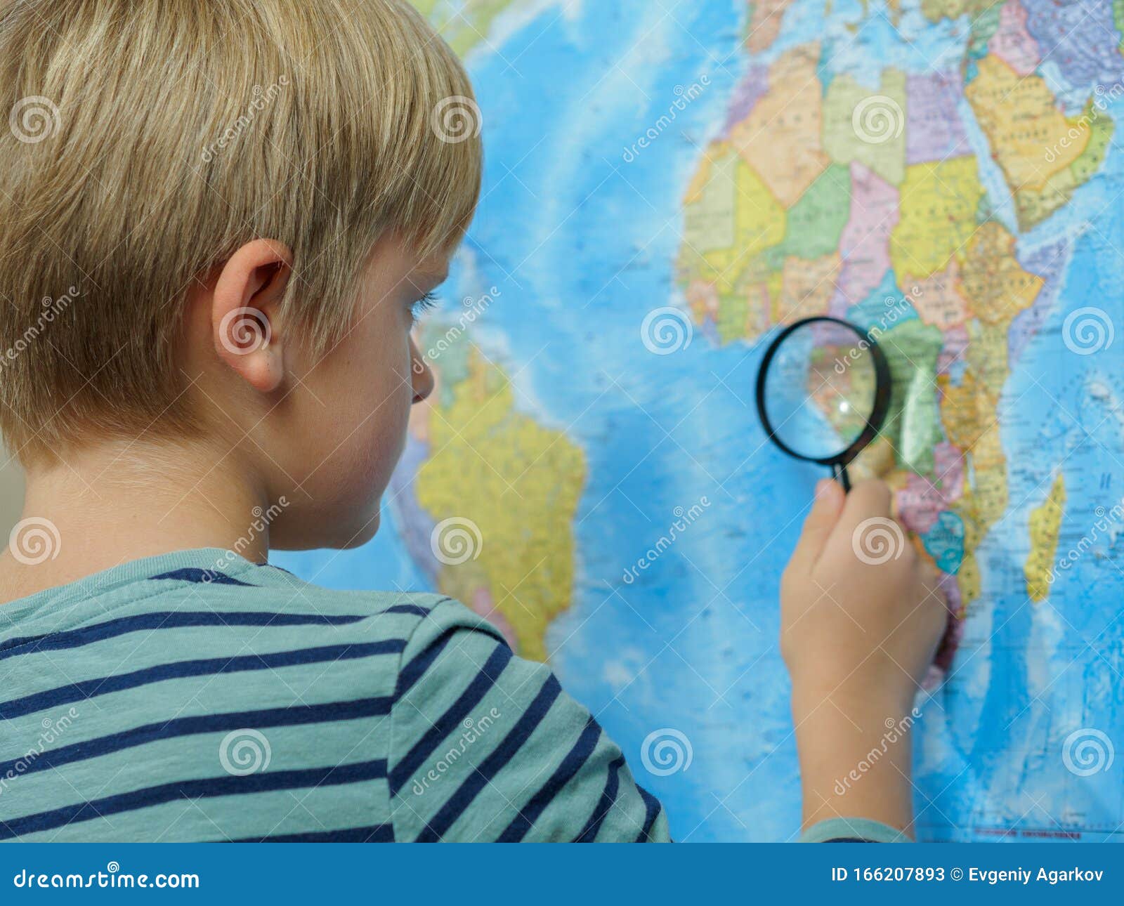 The Boy Looks at the Map through a Magnifying Glass Stock Image - Image ...