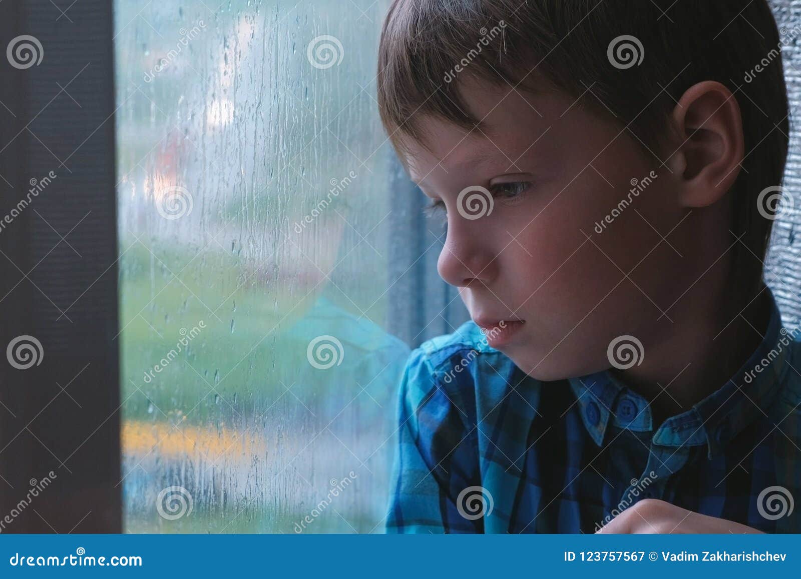 Boy Looks Out the Window in the Rain and is Sad. Stock Image - Image of ...