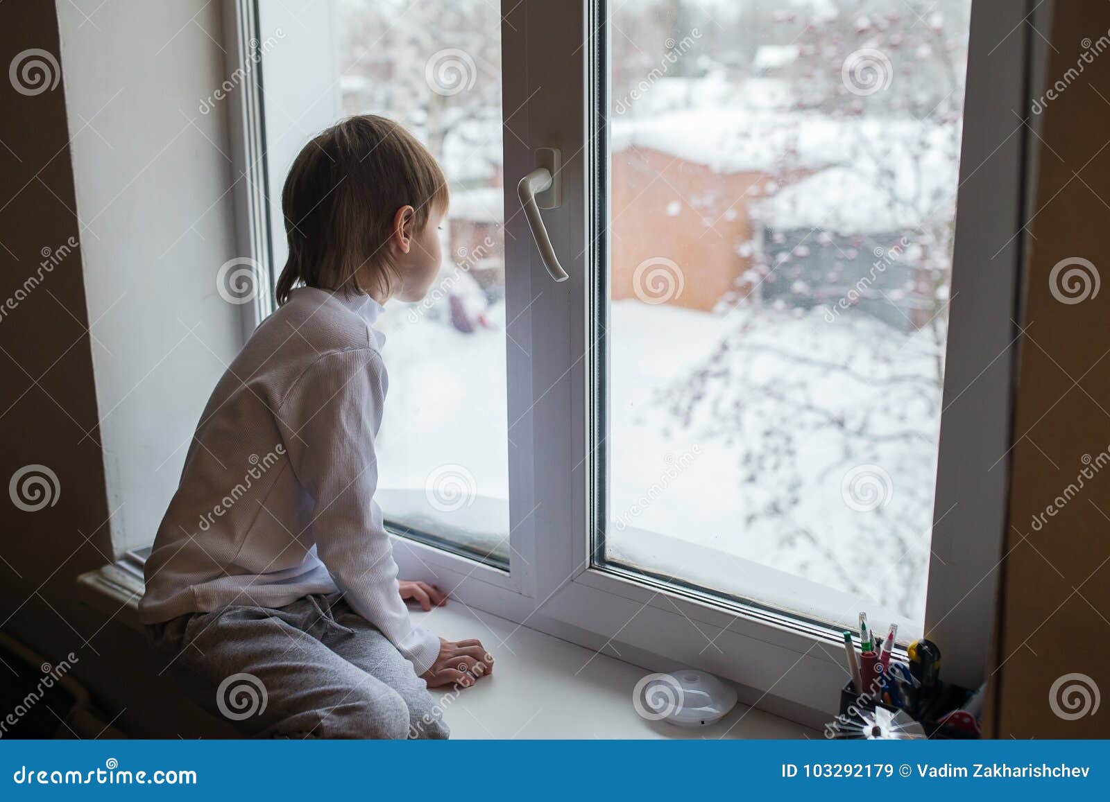 Boy Looks Out the Window on a Winter Day Stock Image - Image of hand ...