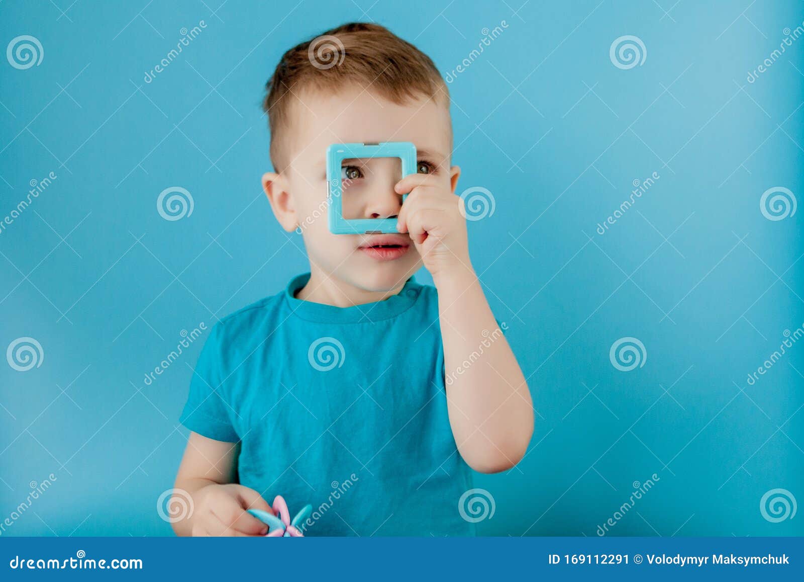 Boy Looks through the Shape in the Color Constructor with the ...