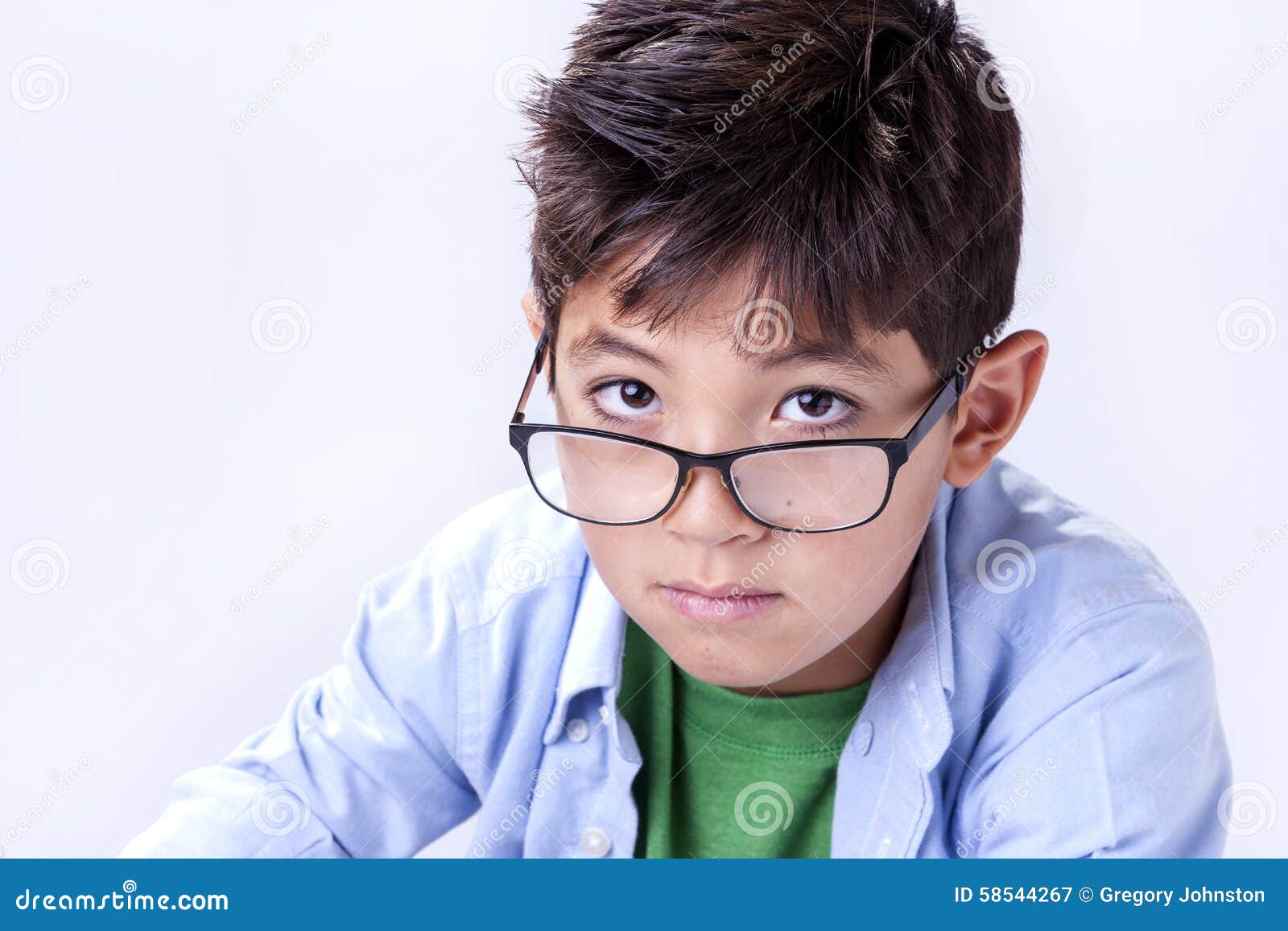 Boy looks up at camera. stock image. Image of eyes, glasses - 58544267