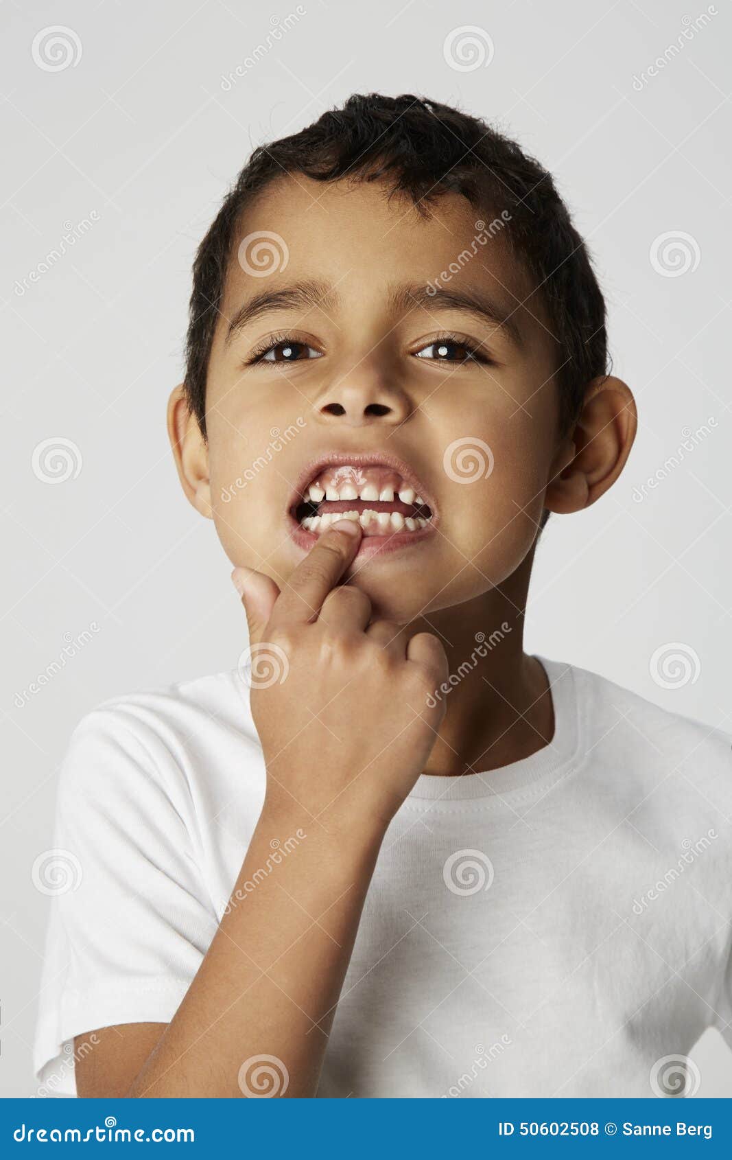 Boy with loose tooth stock photo. Image of hygiene, touching - 50602508